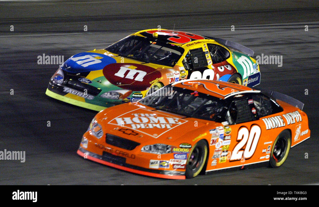 Points leader Tony Stewart (20) drives past Elliott Sadler in early ...