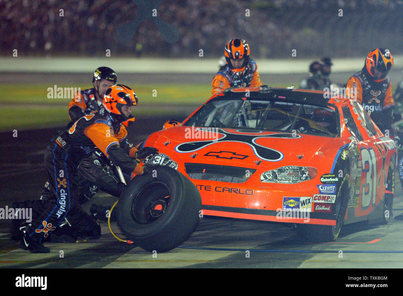 The Cingular Wireless Chevrolet pit crew works on Jeff Burton's car ...