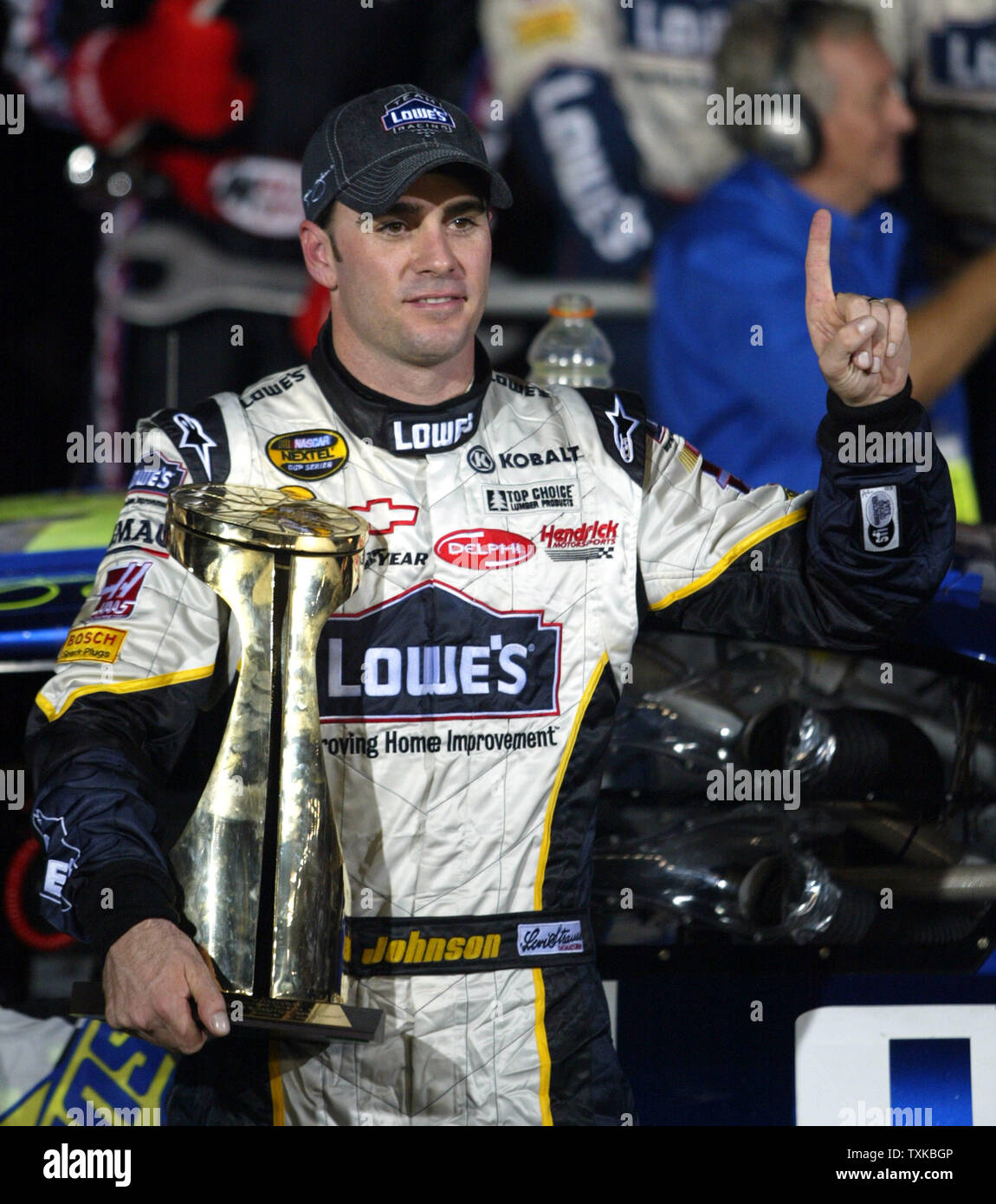 Jimmie Johnson holds his trophy after winning the UAW-GM 500 NASCAR ...