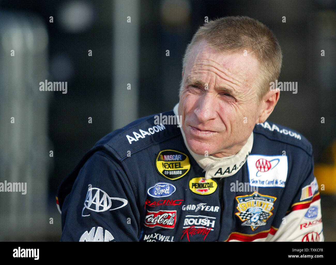 Race car driver Mark Martin awaits the start of qualifying for the Coca ...