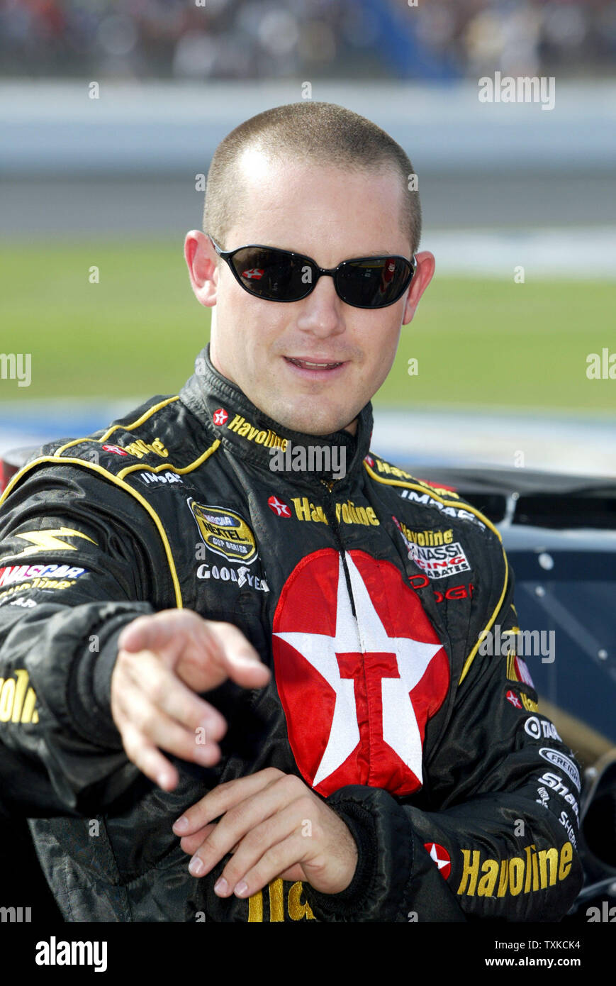 Race car driver Casey Mears waves to fans as he stands by his car ...