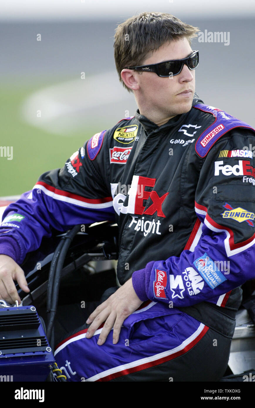 NASCAR driver Denny Hamlin sits in the window of his car before his ...