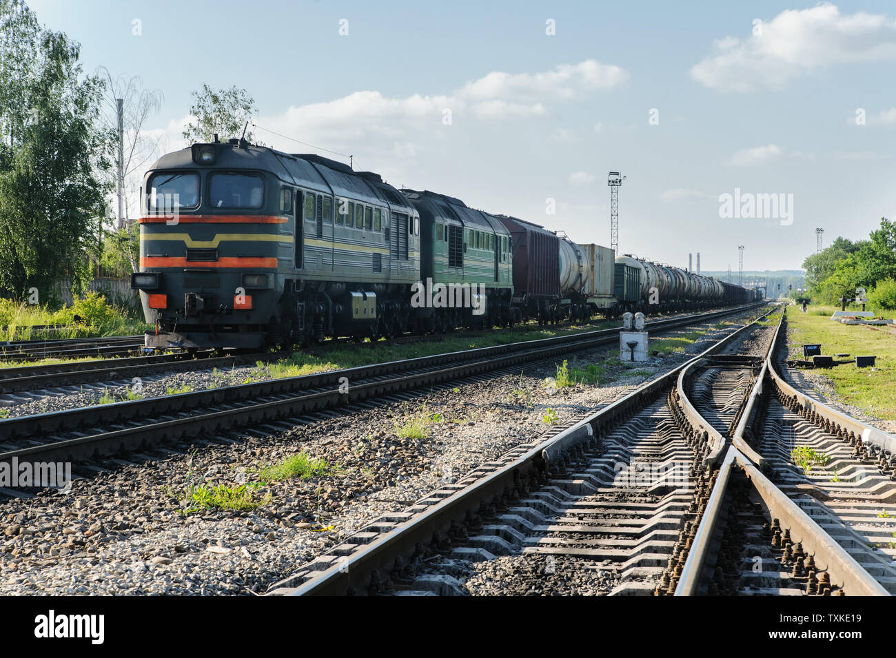 Freight trains on the track. The locomotive is pulling wagons of ...
