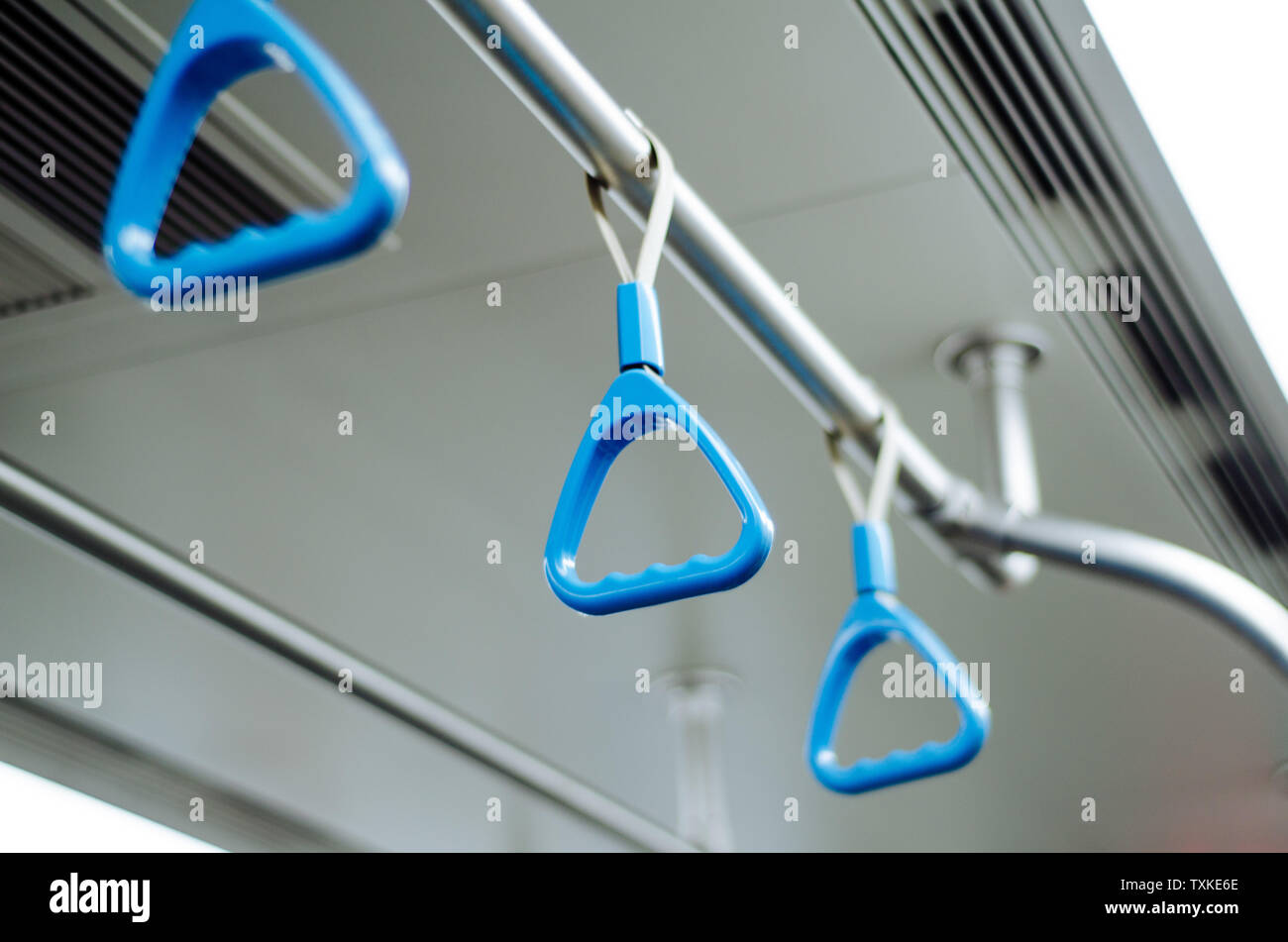 Three blue pull rings on the bus Stock Photo - Alamy