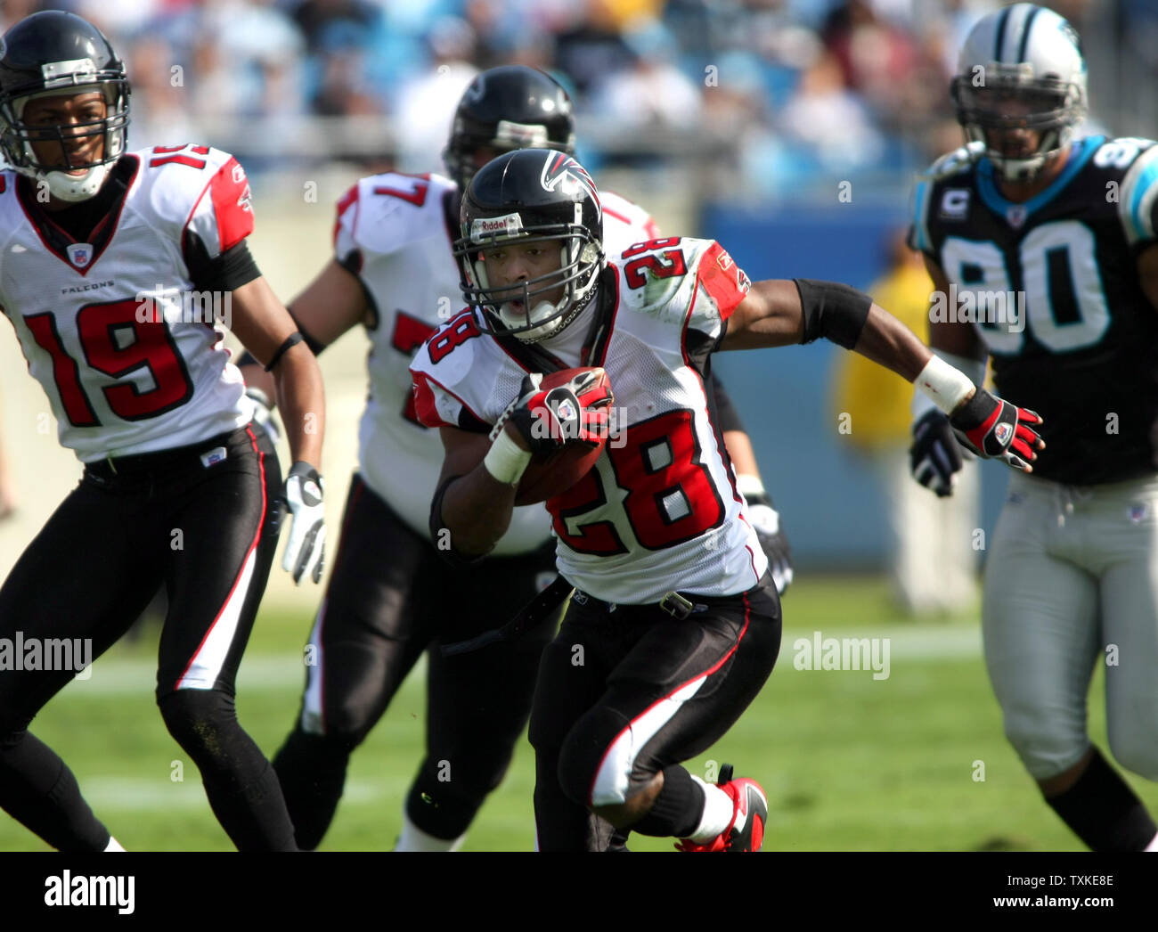 Atlanta Falcons running back Warrick Dunn carries the ball for a 30 ...