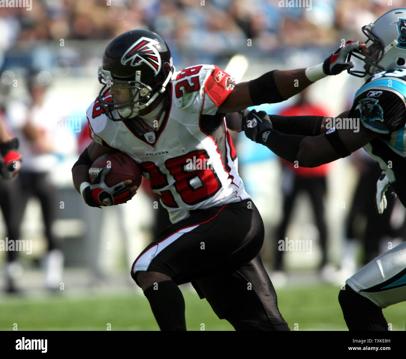 Atlanta Falcons running back Warrick Dunn breaks free from a Carolina ...
