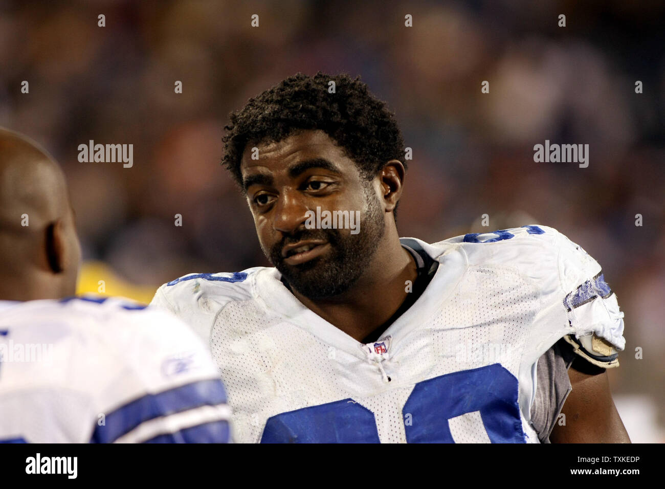Dallas Cowboys linebacker Greg Ellis talks with a teammate as the ...