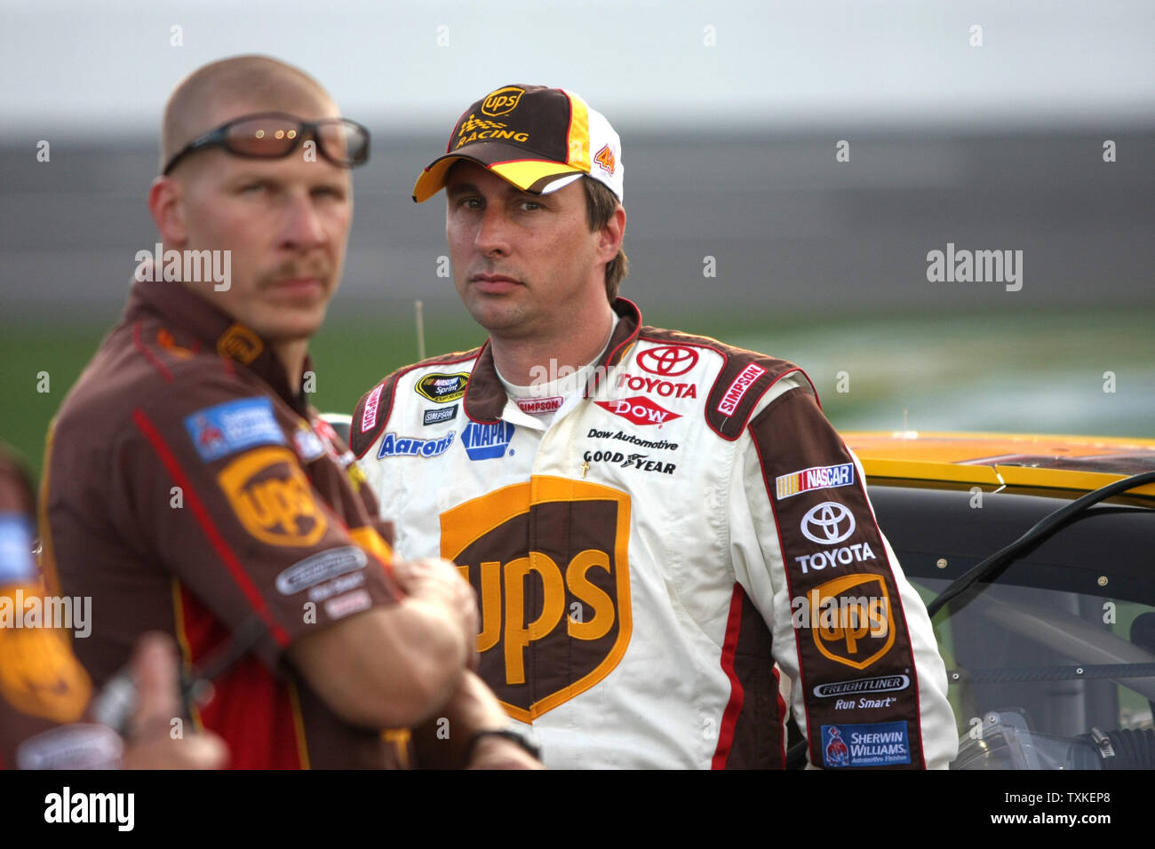NASCAR driver David Reutimann, right, stands by his race car during ...