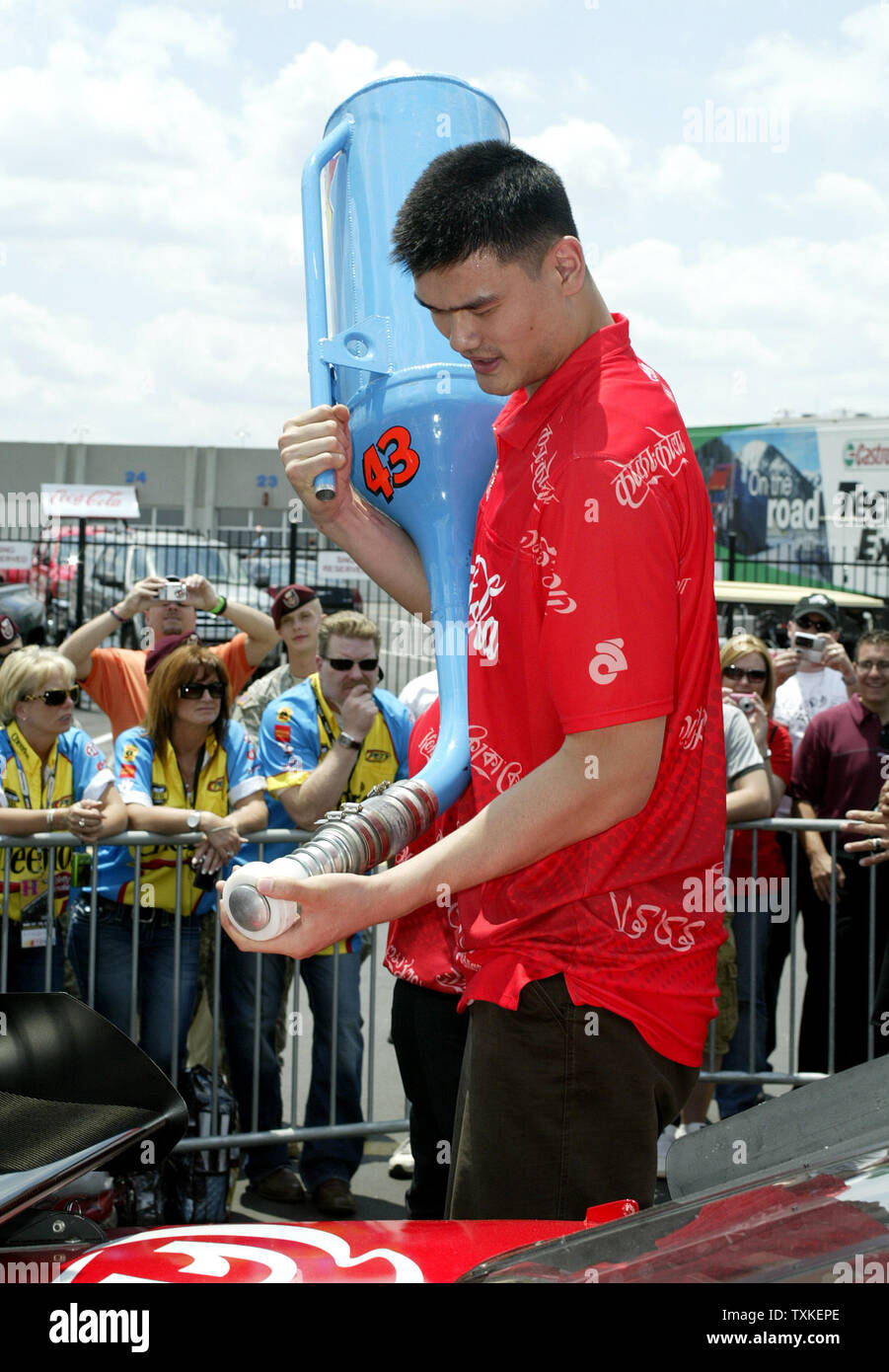 Houston Rockets center Yao Ming of China experiences looks at a gas can ...