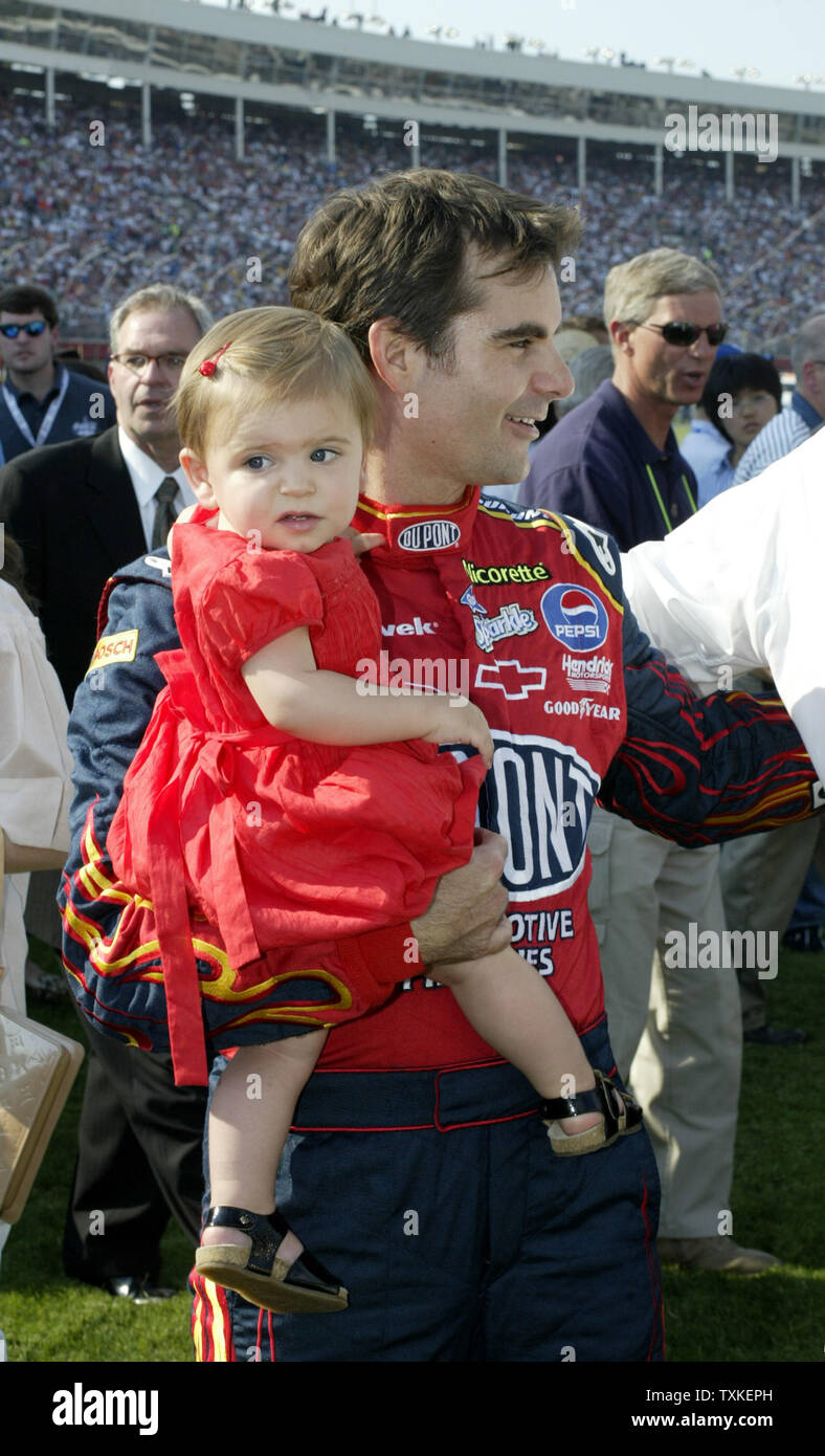Jeff Gordon holds his daughter Ella Sophia before the start of the Coca ...