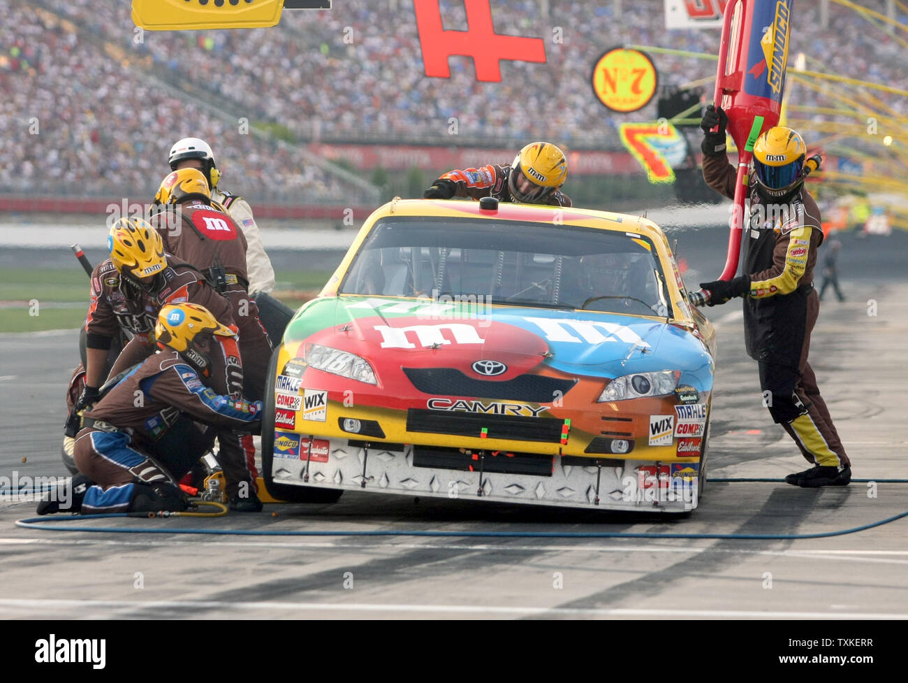 Kyle Busch's pit crew hurries through a pit stop in the Coca-Cola 600 ...