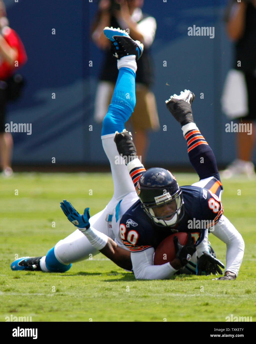 Chicago Bears wide receiver Brandon Lloyd (80) is brought down by ...