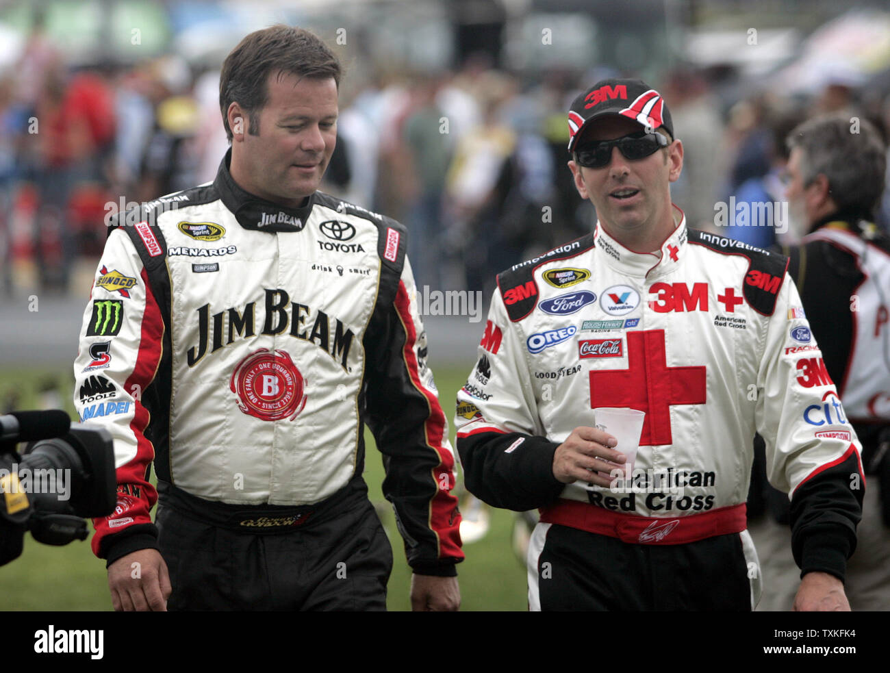 Race car drivers Robby Gordon, left, and Greg Biffle talk during driver ...