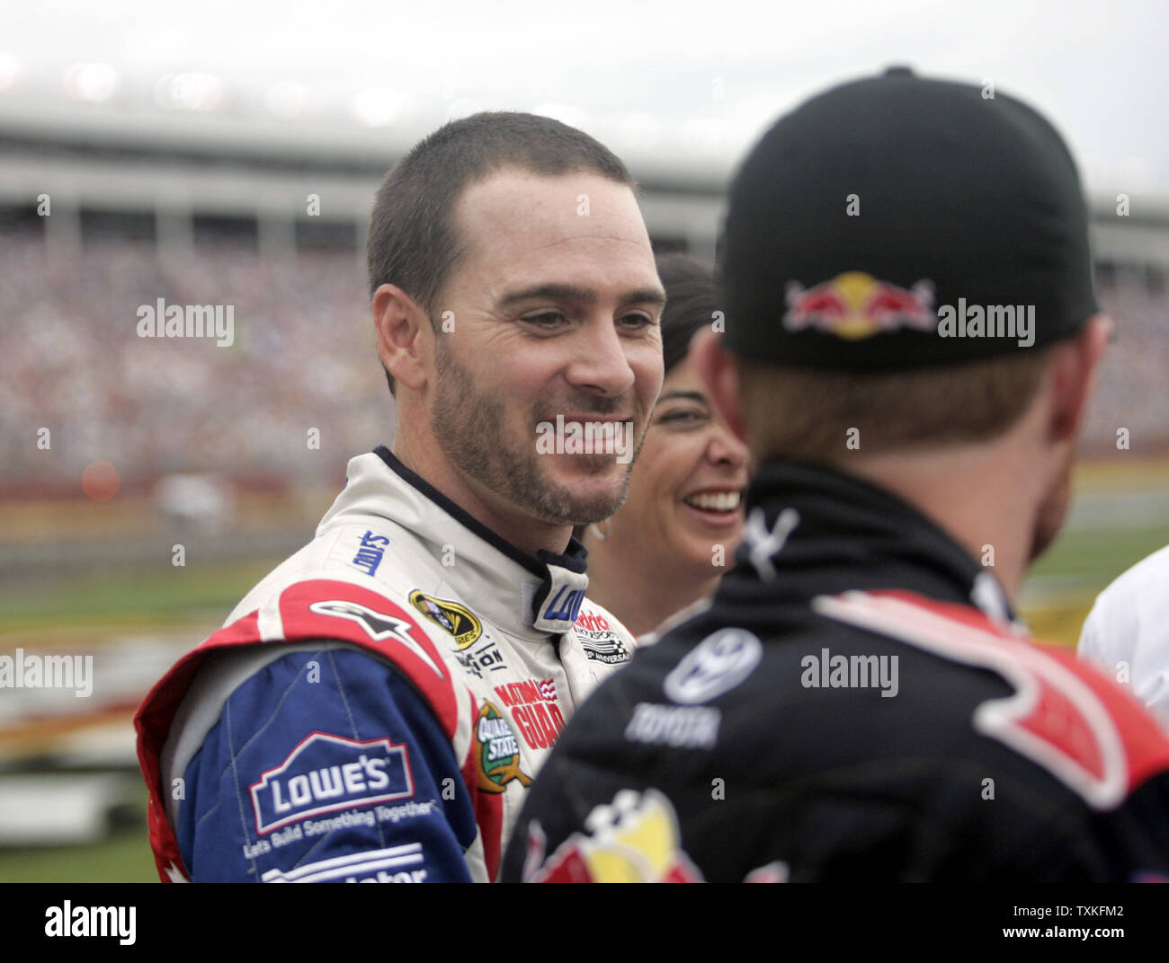 Race car drivers Brian Vickers, right, and Jimmie Johnson talk before ...