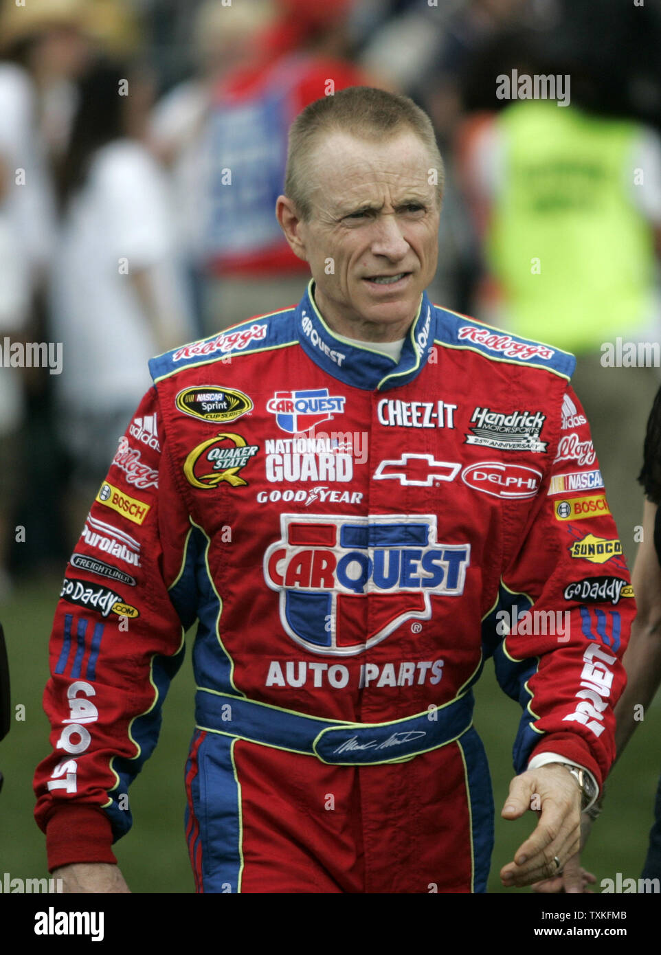 Race car driver Mark Martin walks down pit road during driver ...
