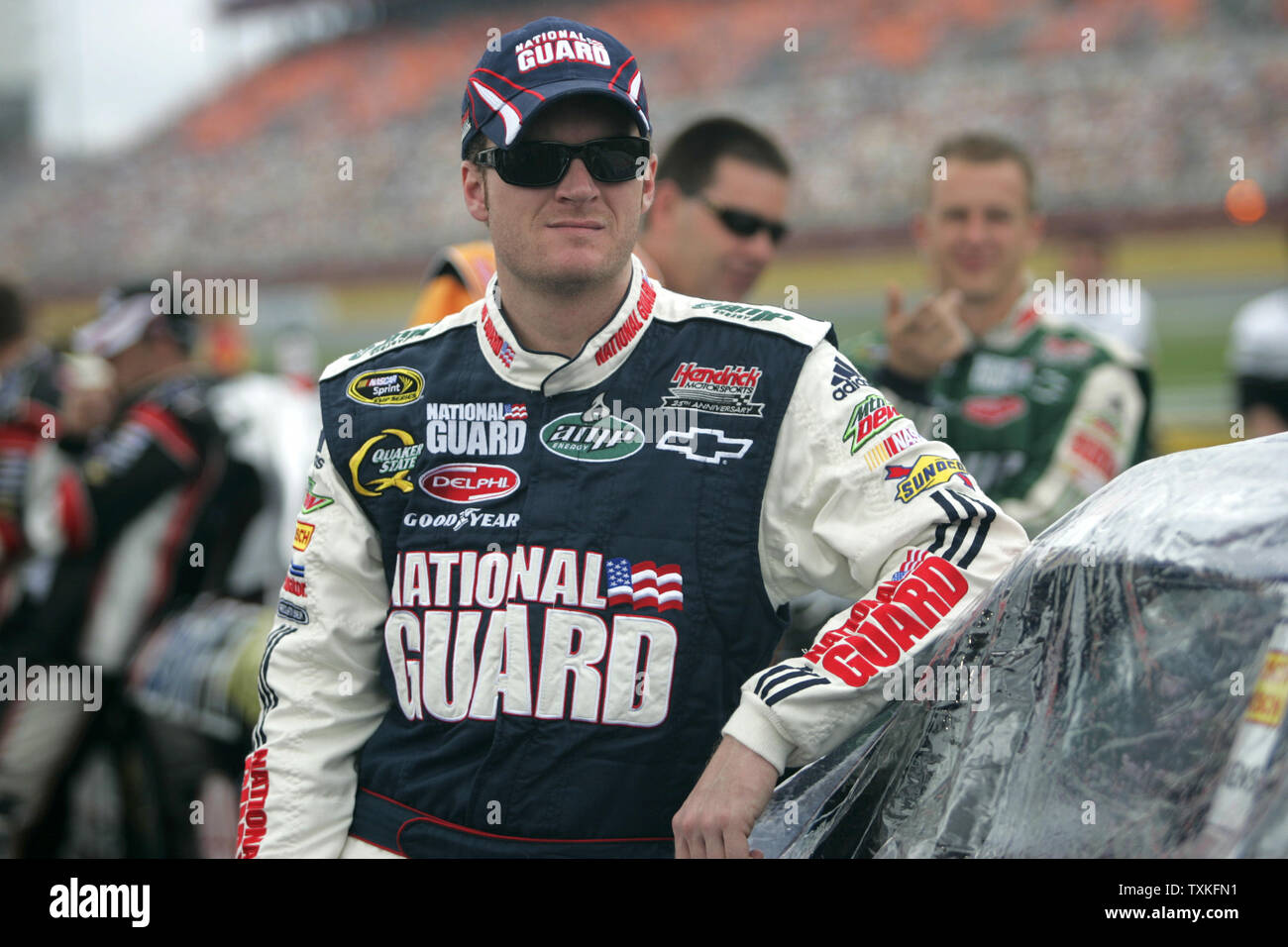 Race car driver Dale Earnhardt Jr. stands by his car before the NASCAR ...