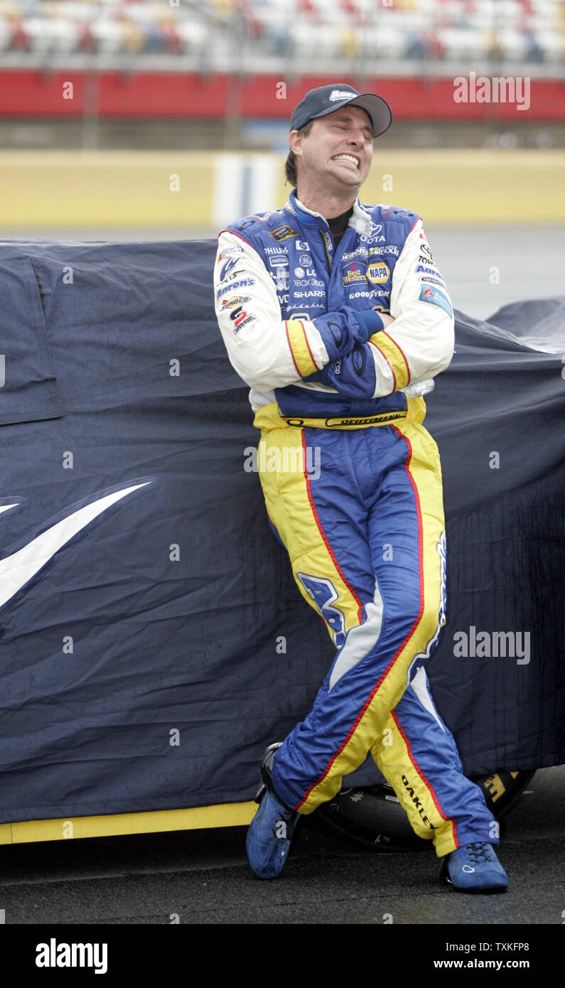 Race car driver David Reutimann stands in the rain at lap 220, when the ...