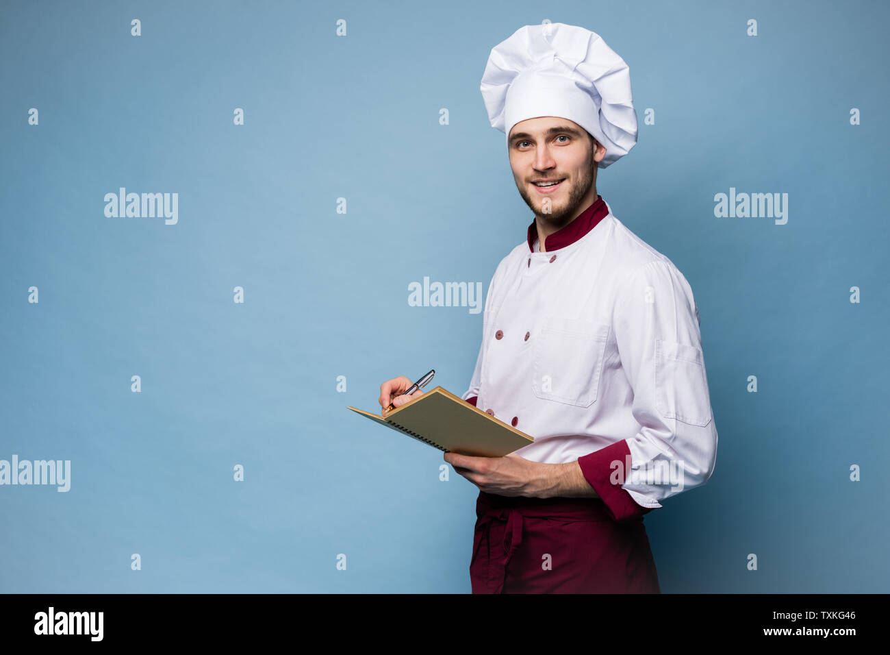 Chef holding his recipe book hi-res stock photography and images - Alamy