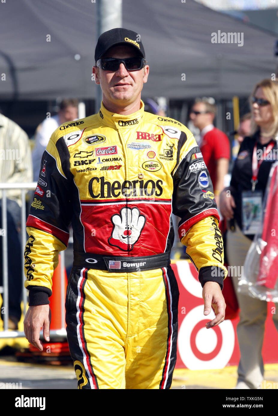 Race car driver Clint Bowyer walks through the pits before the start of ...