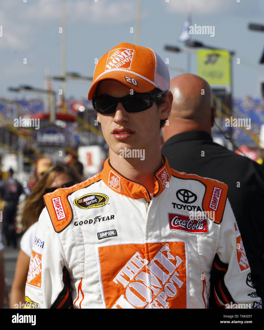 Race car driver Joey Logano walks through the pits before the start of ...