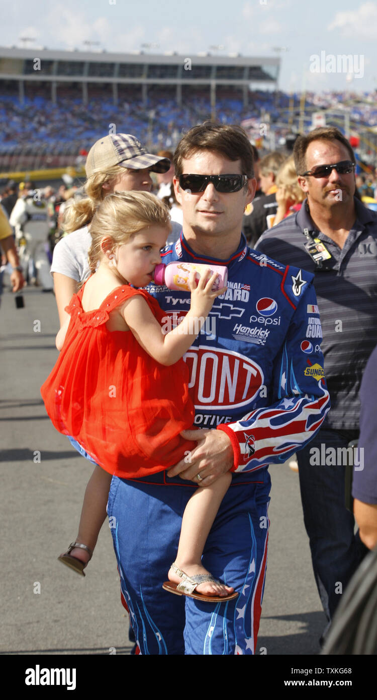 Race car driver Jeff Gordon carries his daughter Ella Sophia Gordon as ...