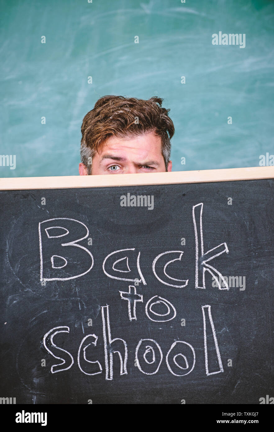 Teacher or school principal behind inscription back to school. Teacher ...