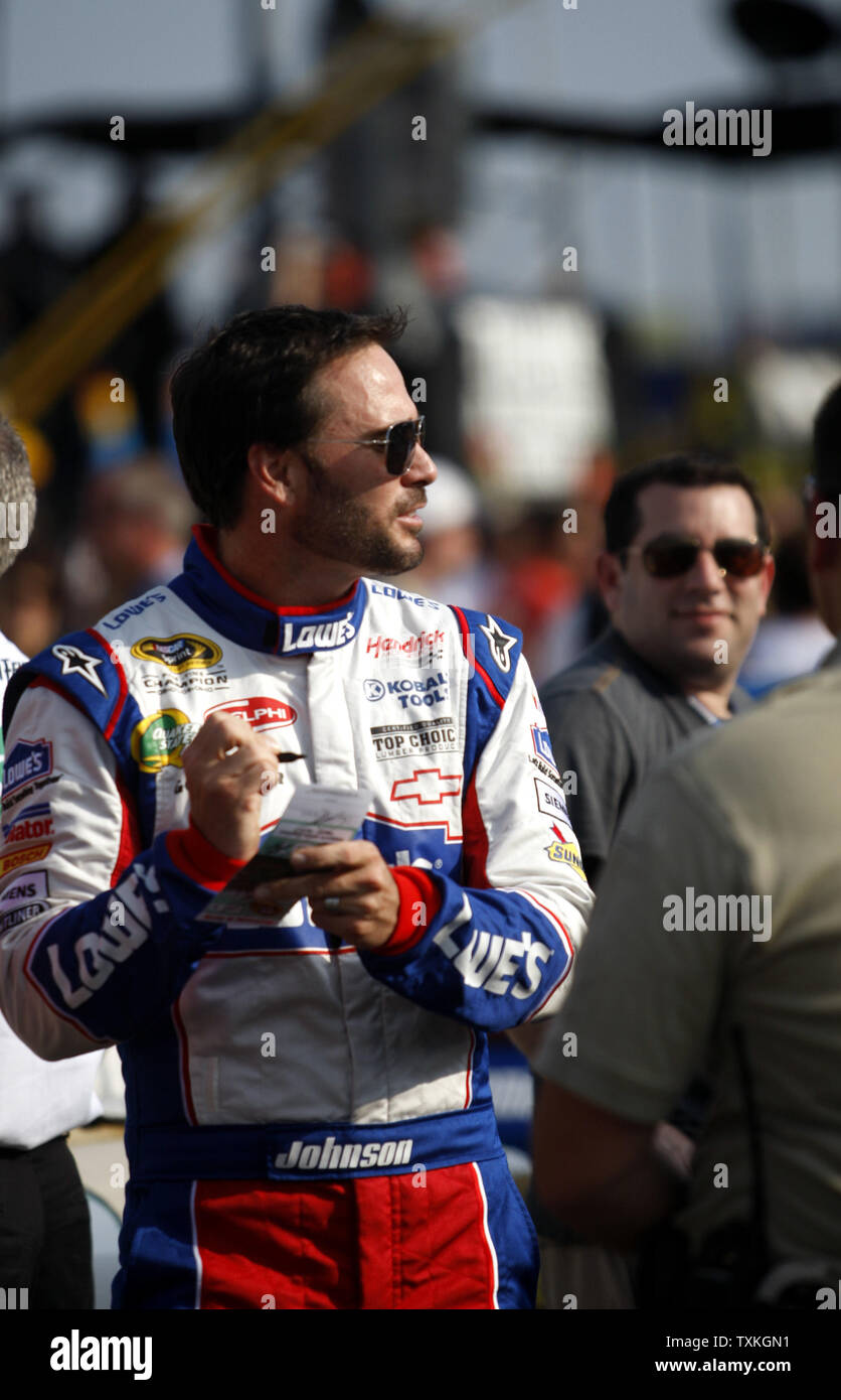 Race car driver Jimmie Johnson signs autographs on pit road before the ...