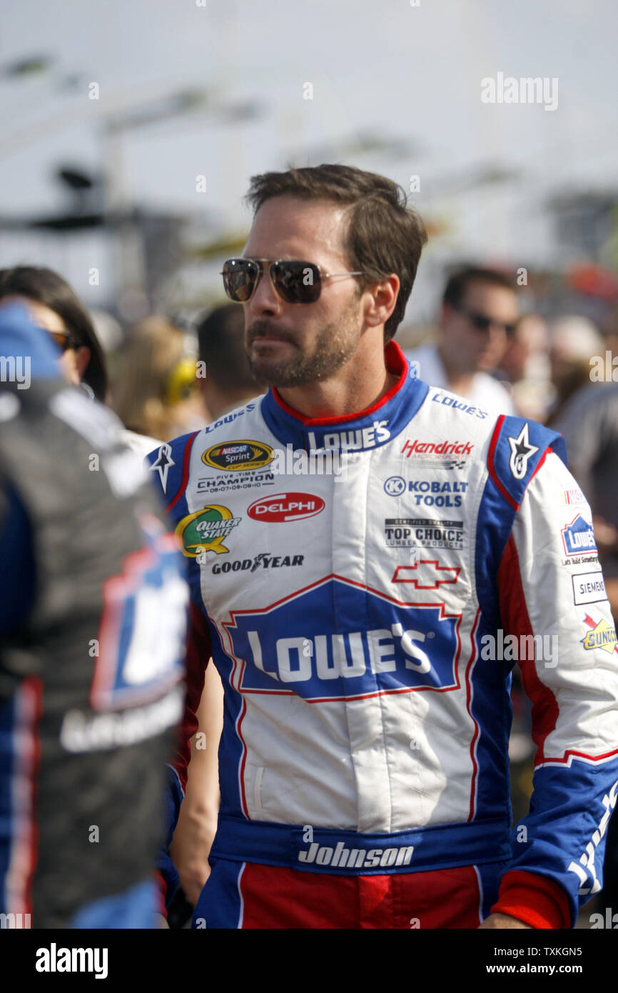 Race car driver Jimmie Johnson walks on pit road before the NASCAR Coca ...