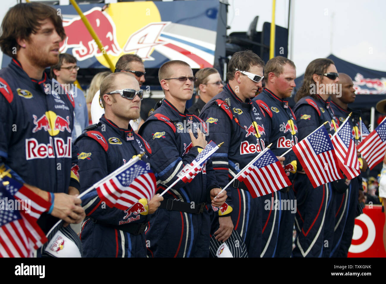 The Red Bull Toyota pit crew hold flags during the National Anthem ...