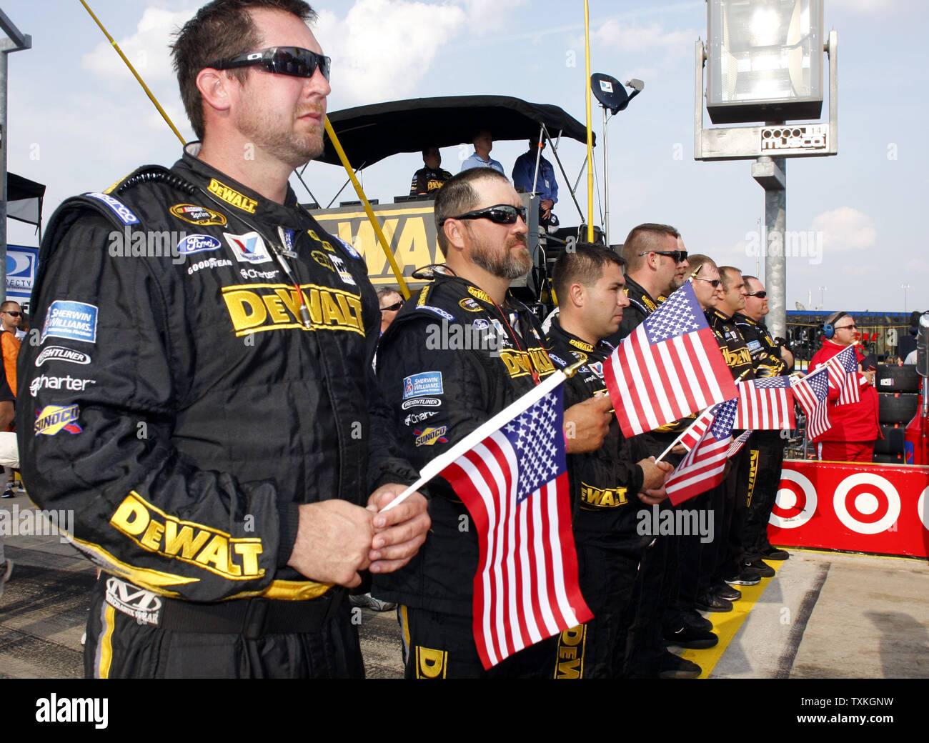 The DeWalt Ford pit crew hold flags during the pre-race ceremony on pit ...