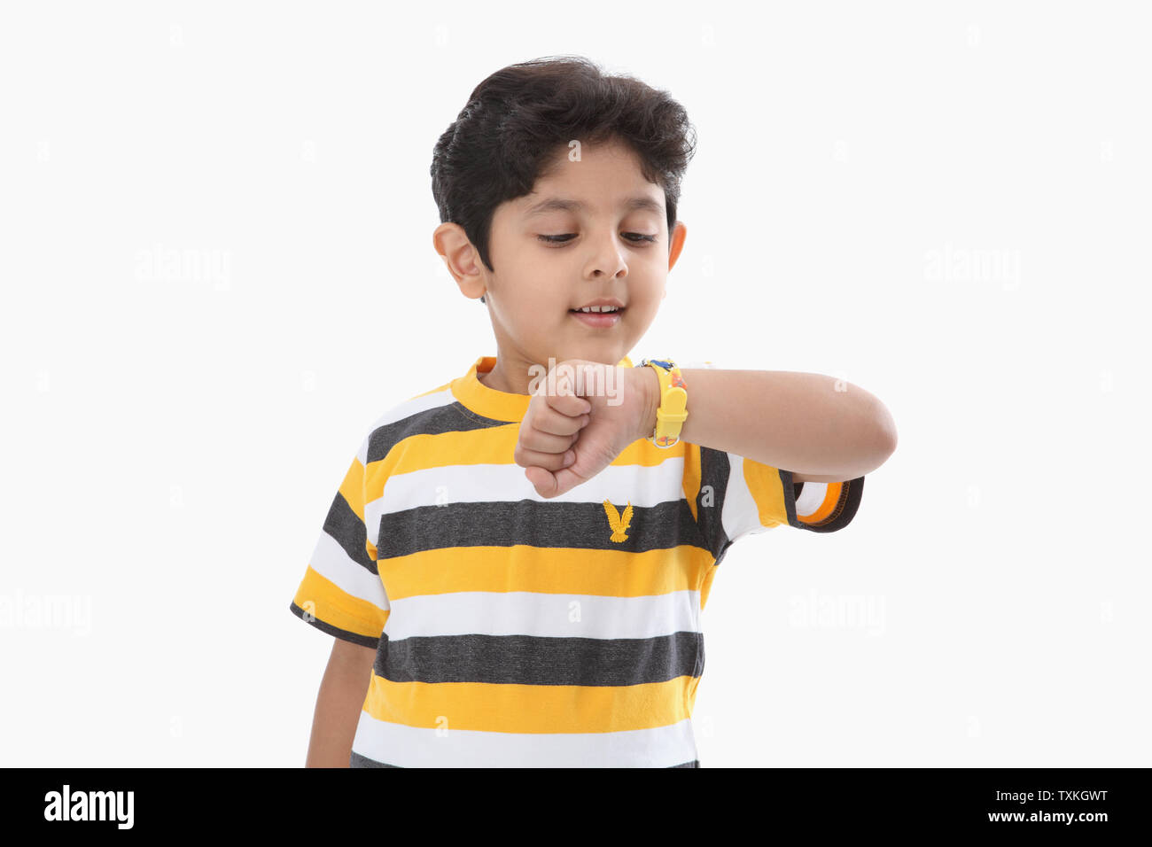 Boy looking at his wristwatch Stock Photo - Alamy