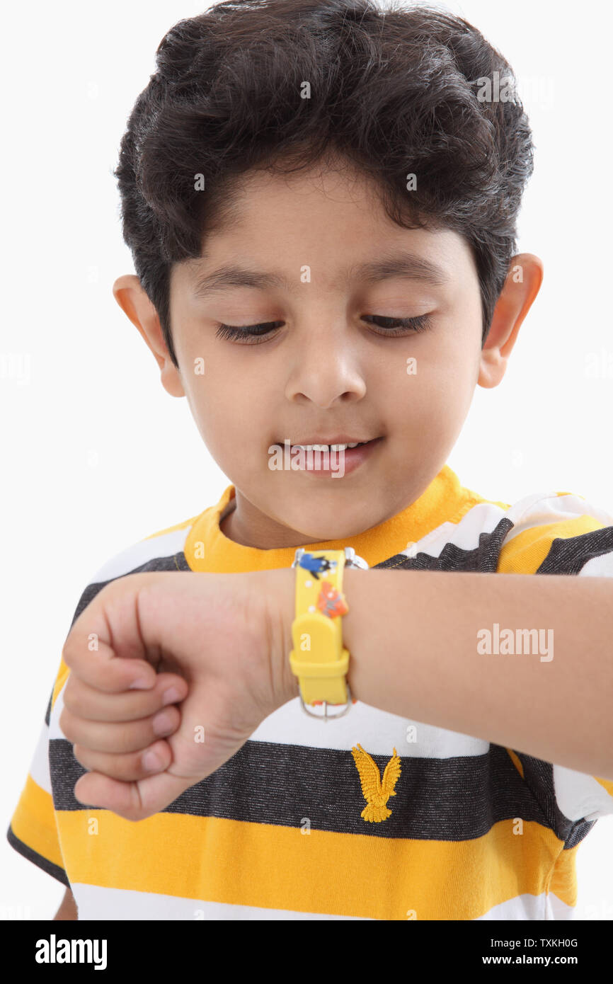 Indian boy checking the time at his wristwatch Stock Photo - Alamy