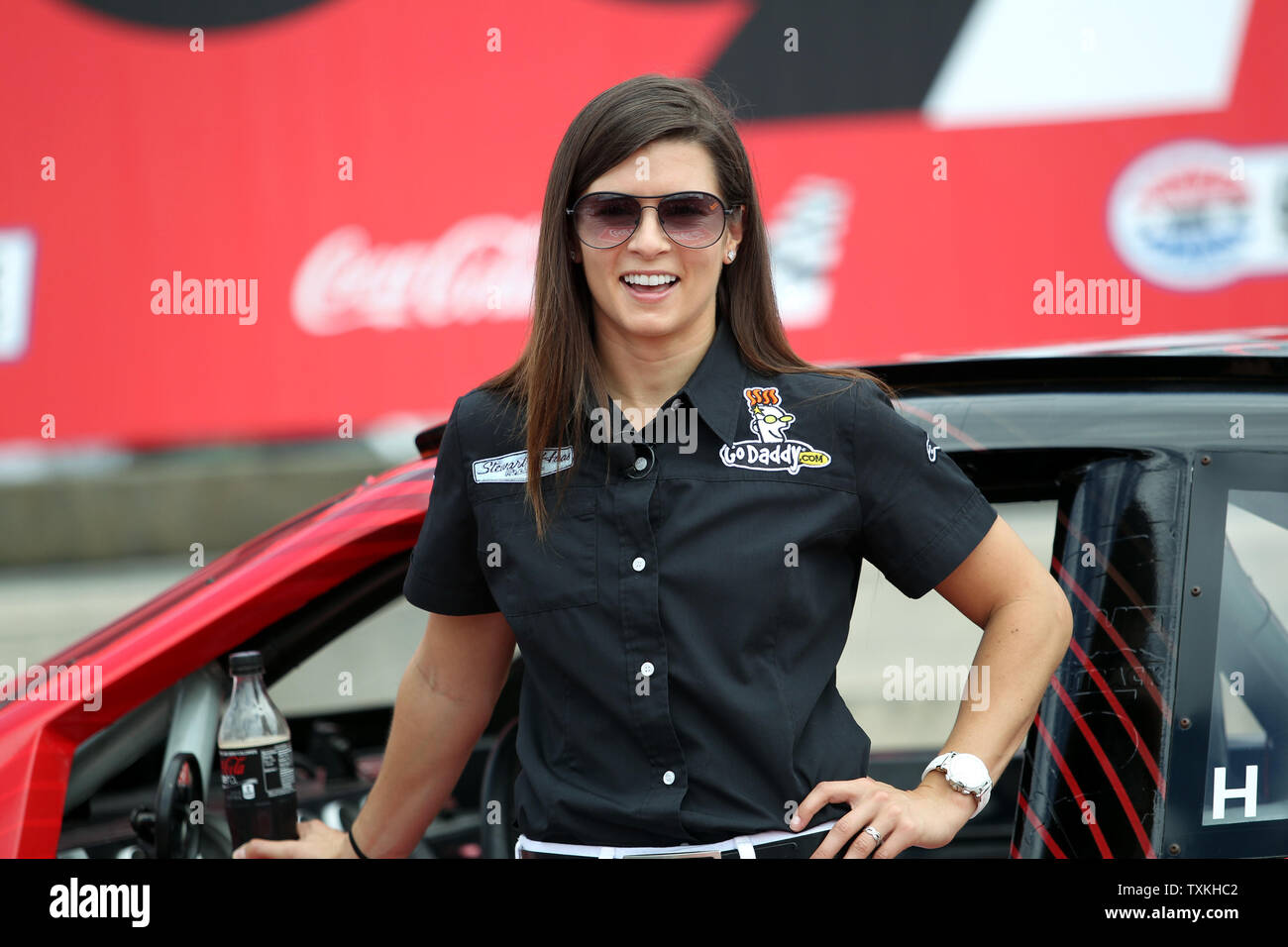 Race car driver Danica Patrick stands by a car during an appearance ...