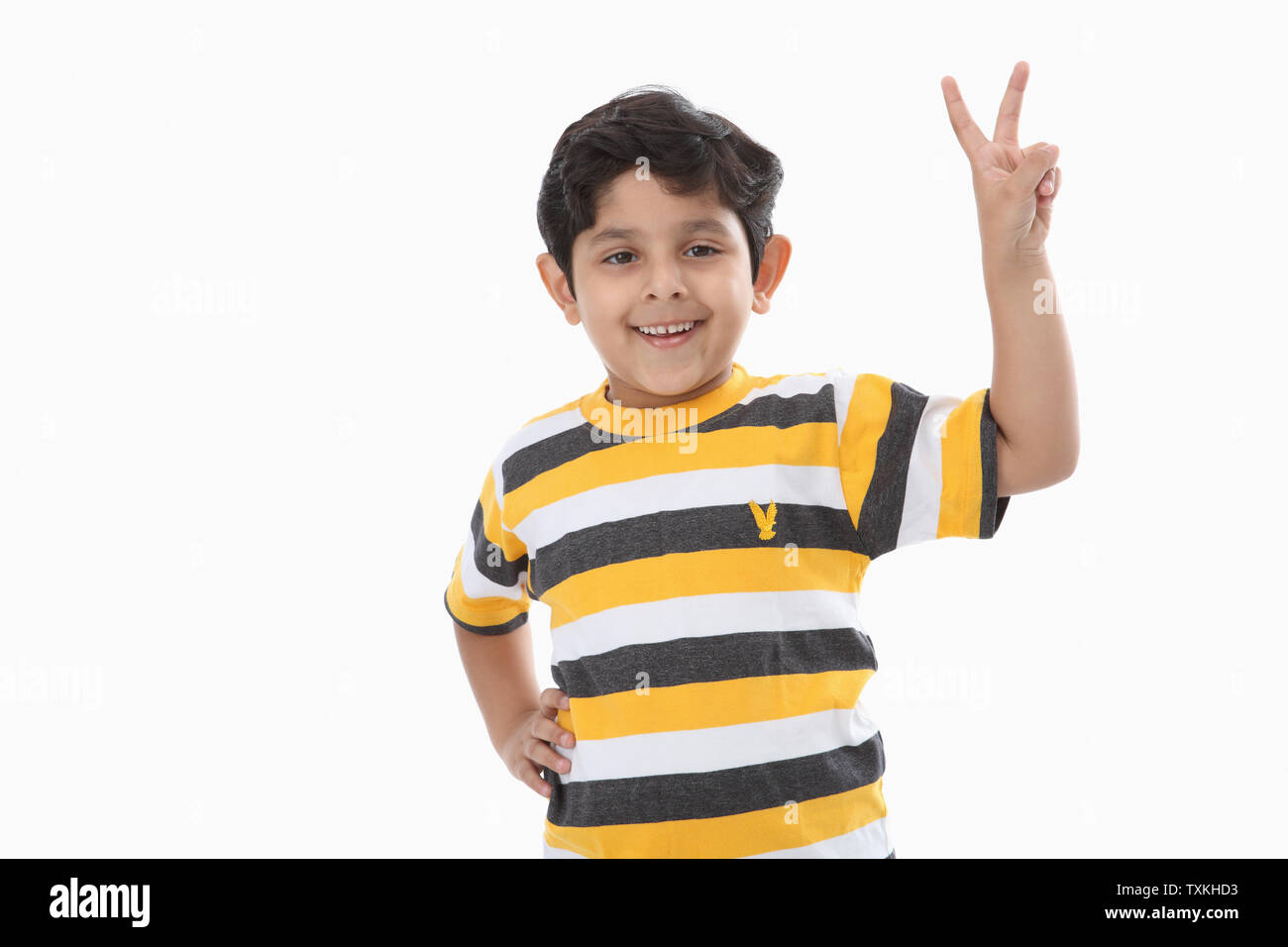 Portrait of a boy showing v sign Stock Photo - Alamy