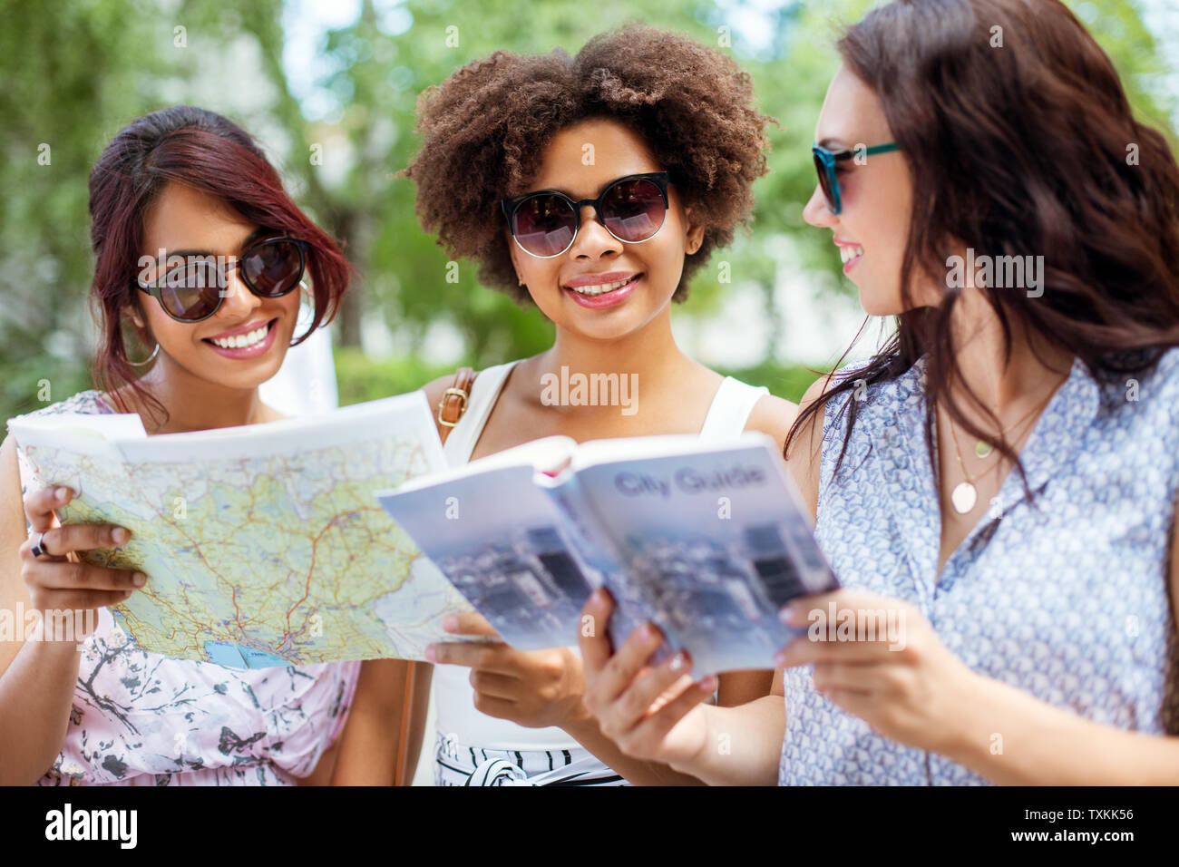 women with map and city guide on street in summer Stock Photo - Alamy