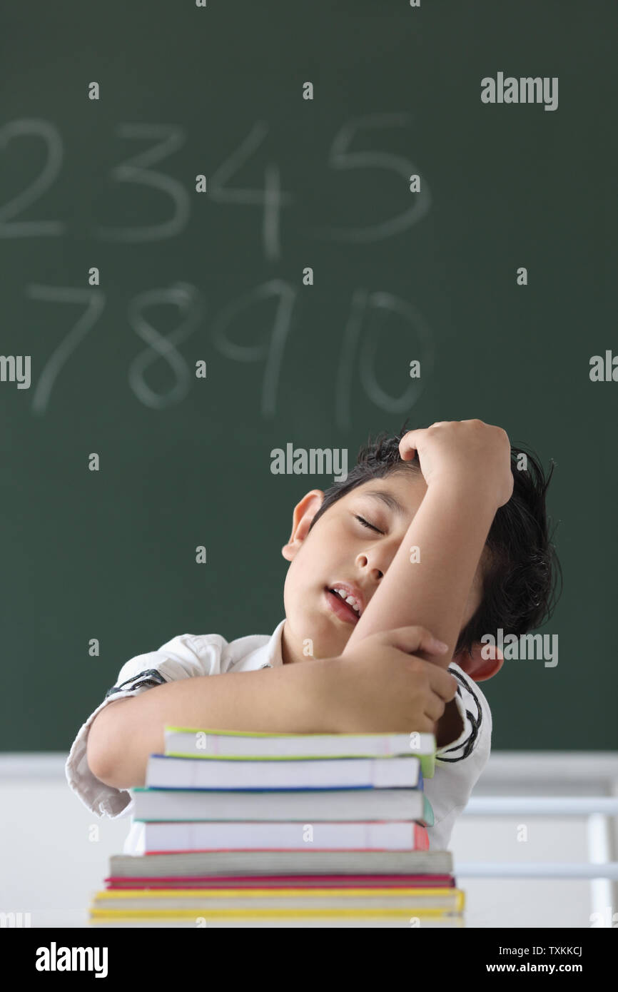Schoolboy napping in a classroom Stock Photo - Alamy