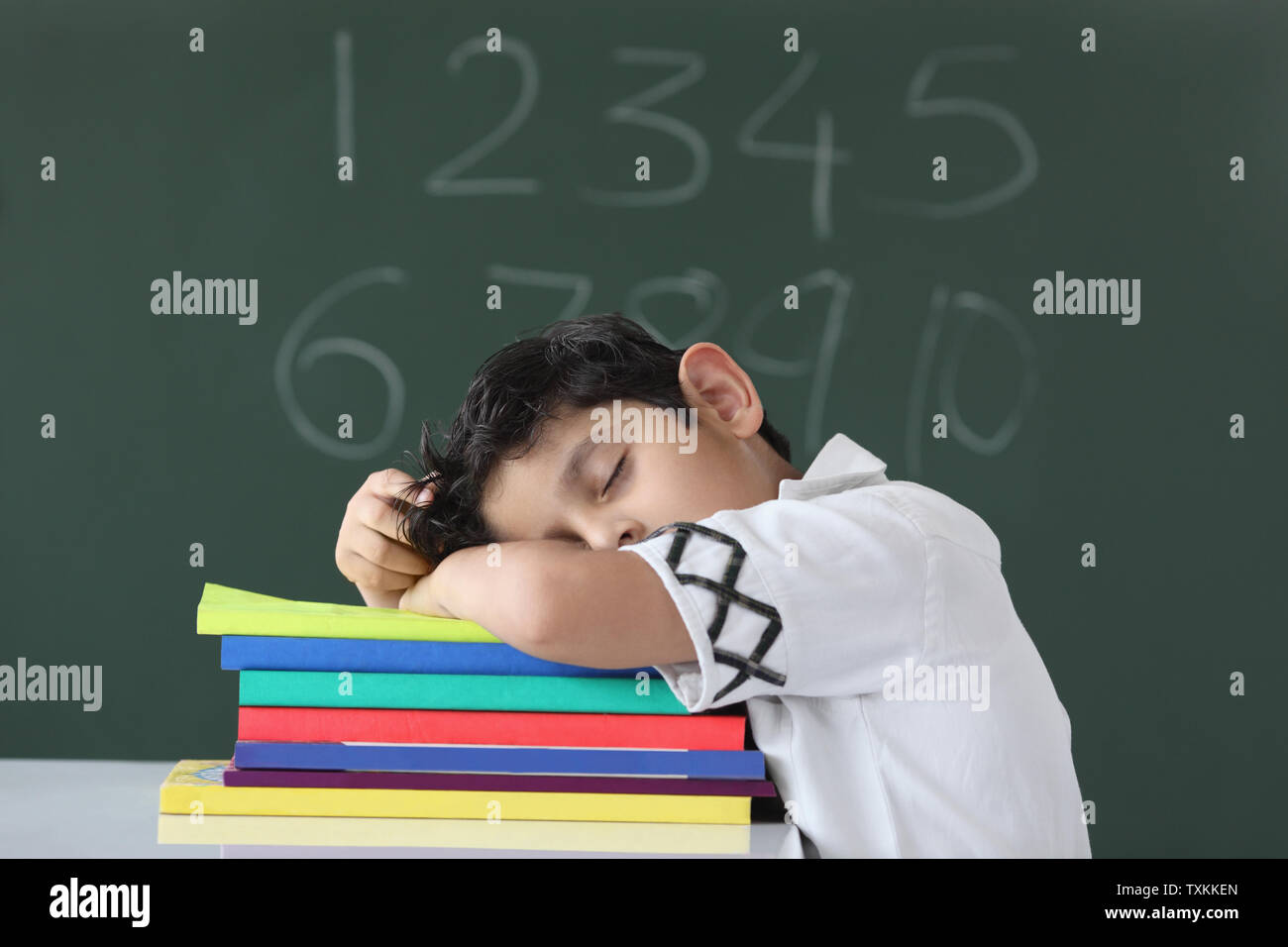 Schoolboy napping in a classroom Stock Photo - Alamy