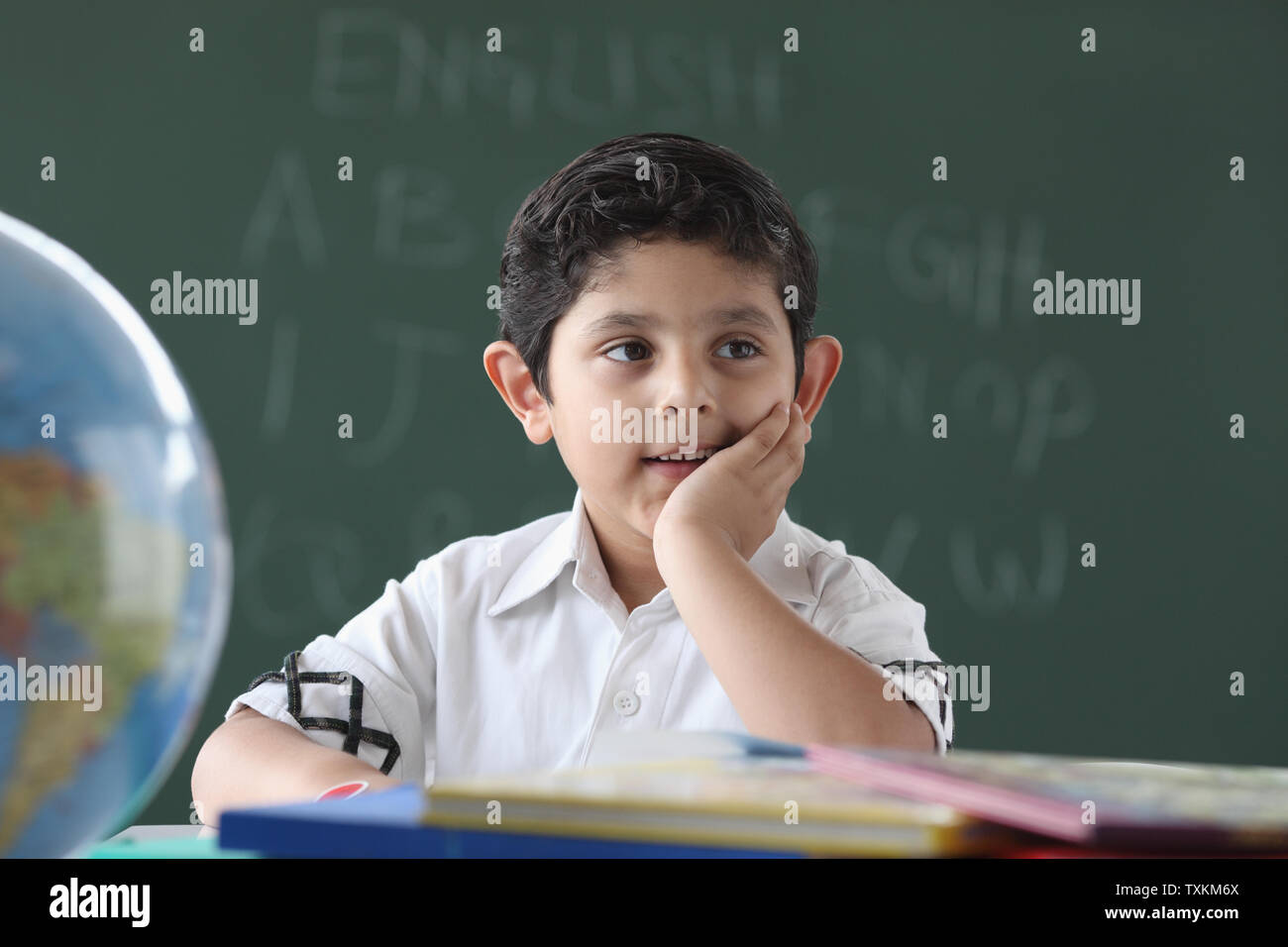 Student reading in a classroom Stock Photo - Alamy