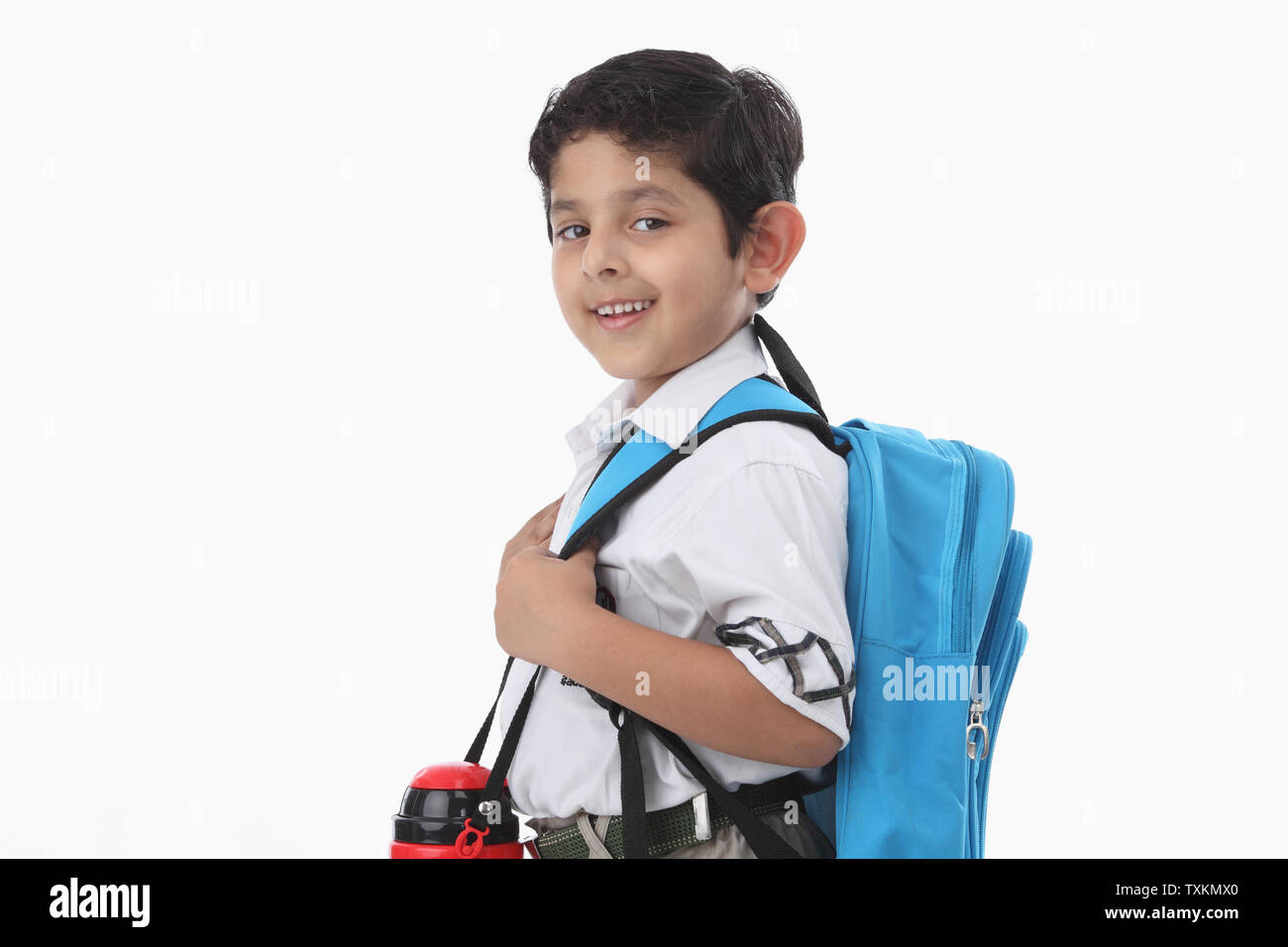 Schoolboy with a book bag and smiling Stock Photo - Alamy