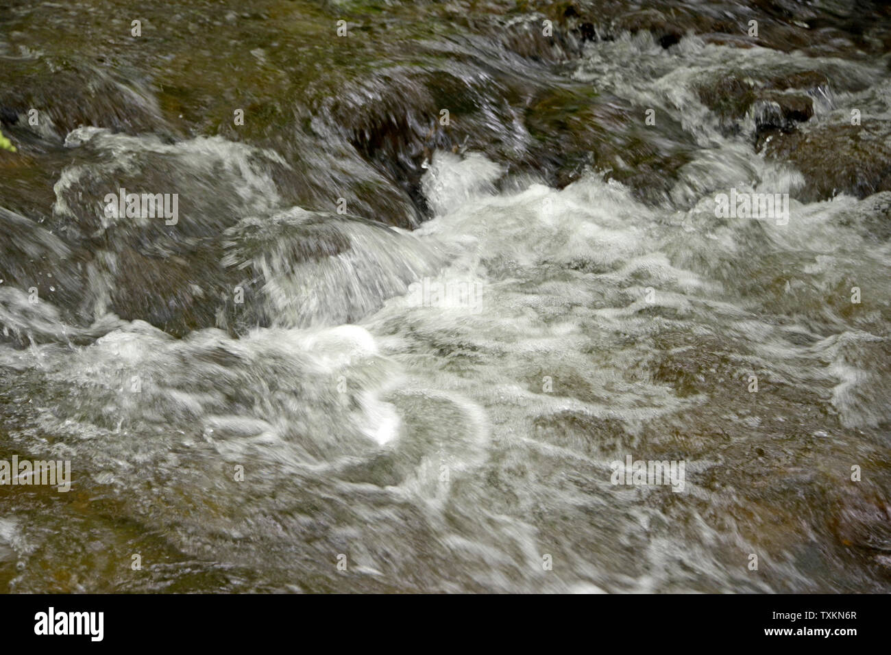 Stream flowing into rocks hi-res stock photography and images - Alamy