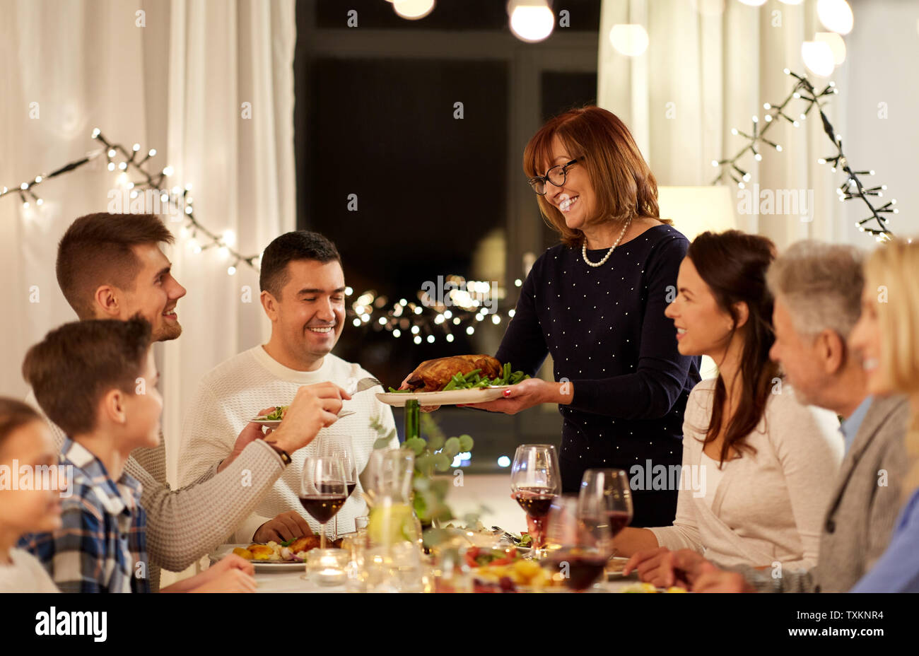 happy family having dinner party at home Stock Photo - Alamy
