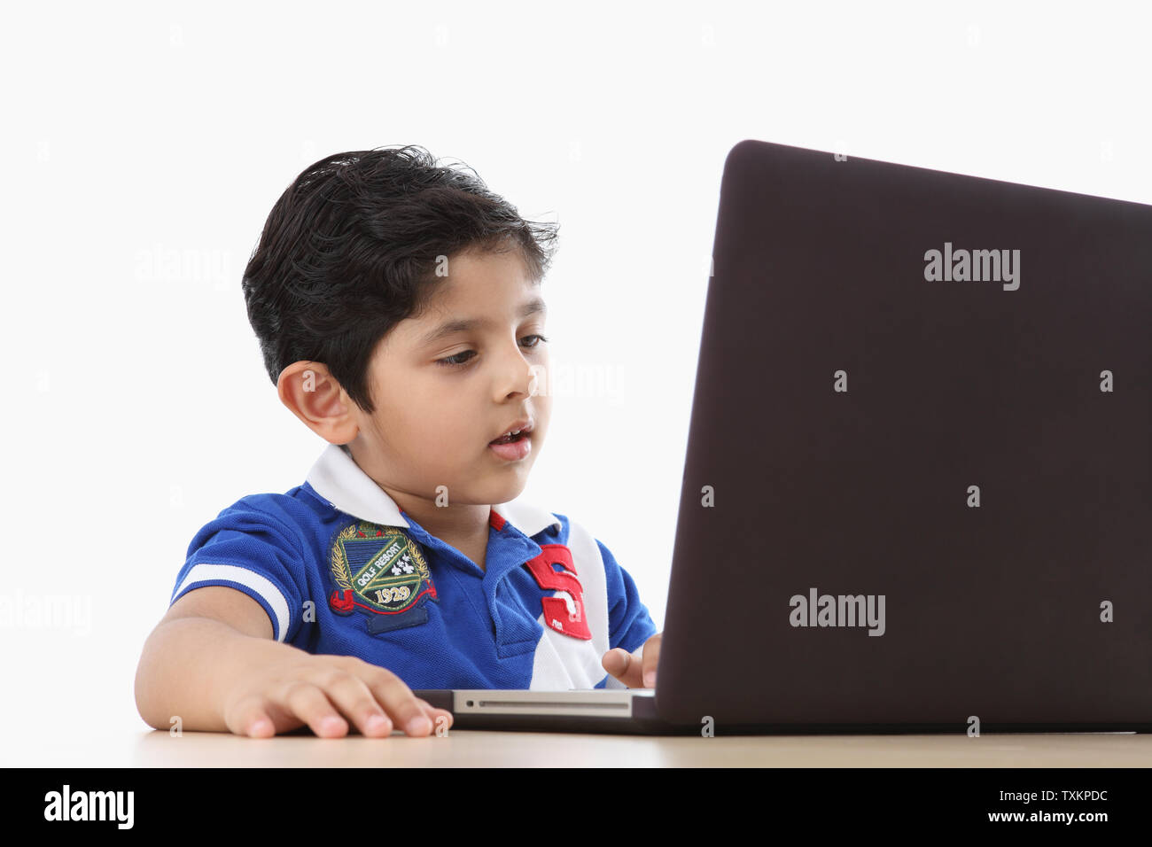 Boy working on a laptop Stock Photo - Alamy