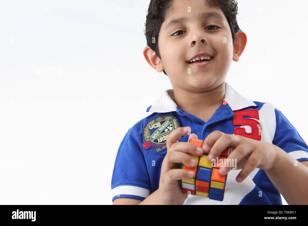 Boy playing with a puzzle cube Stock Photo - Alamy