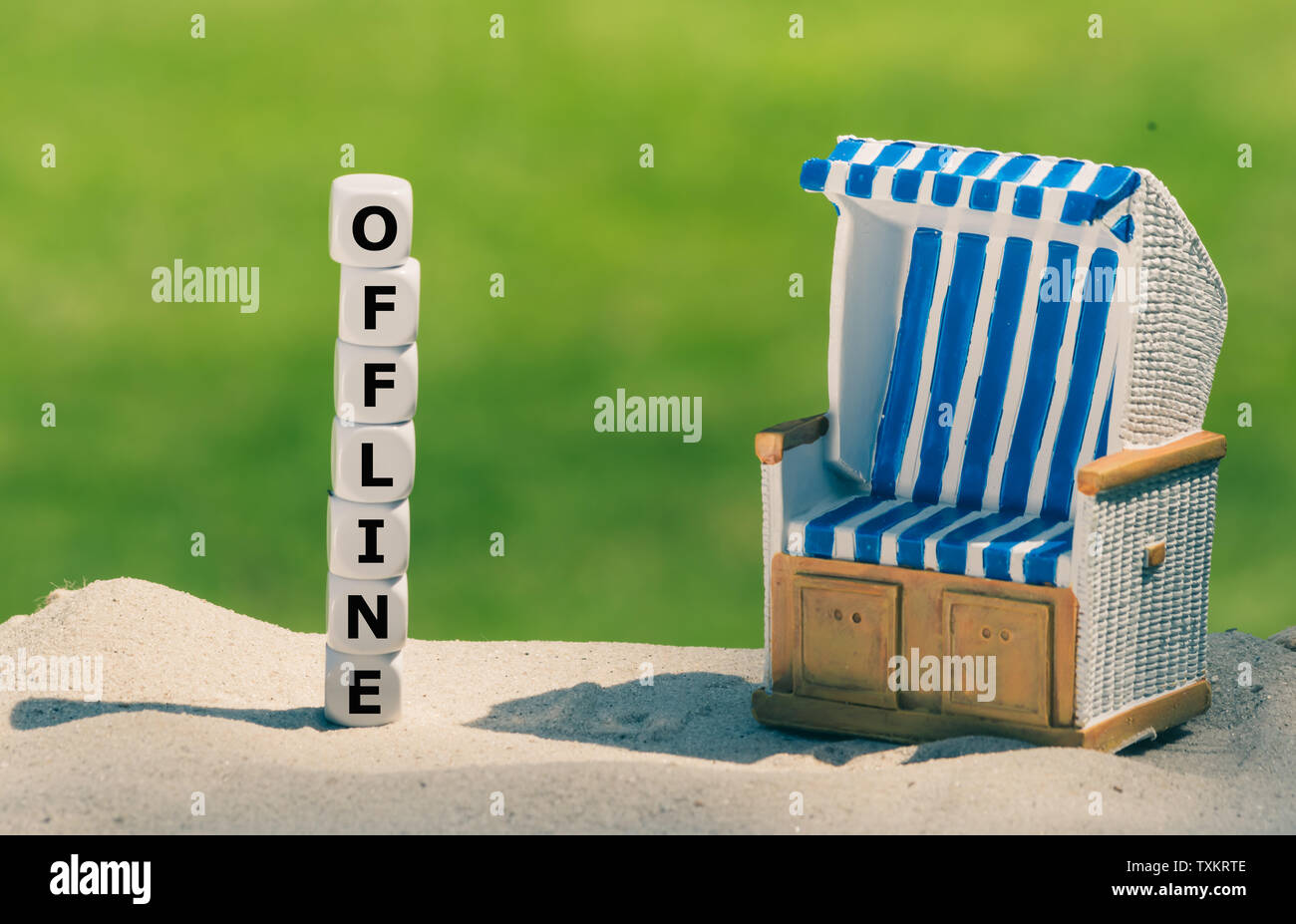 Concept for being offline. Dice form the word "offline" next to a beach ...