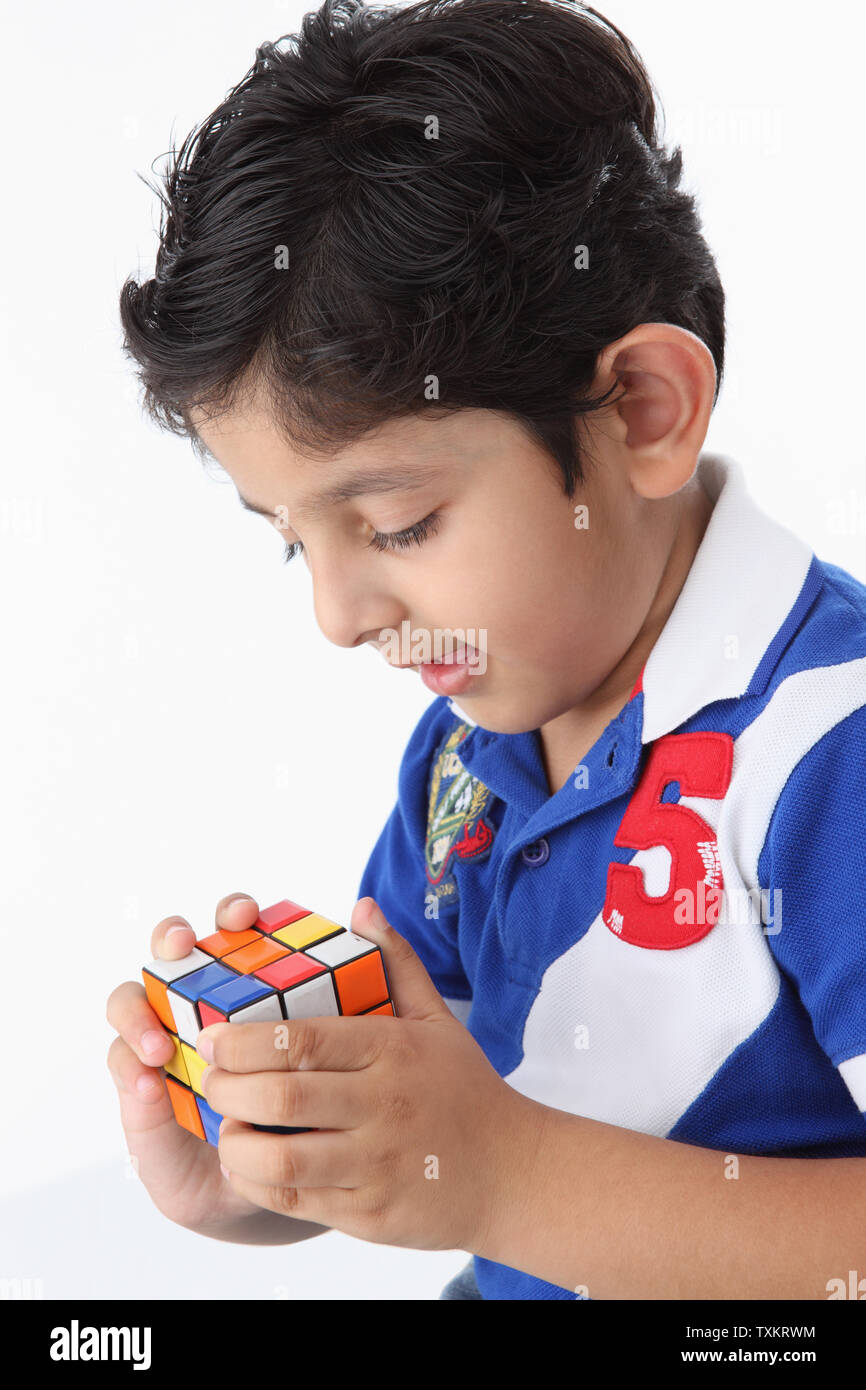 Boy playing with a puzzle cube Stock Photo - Alamy