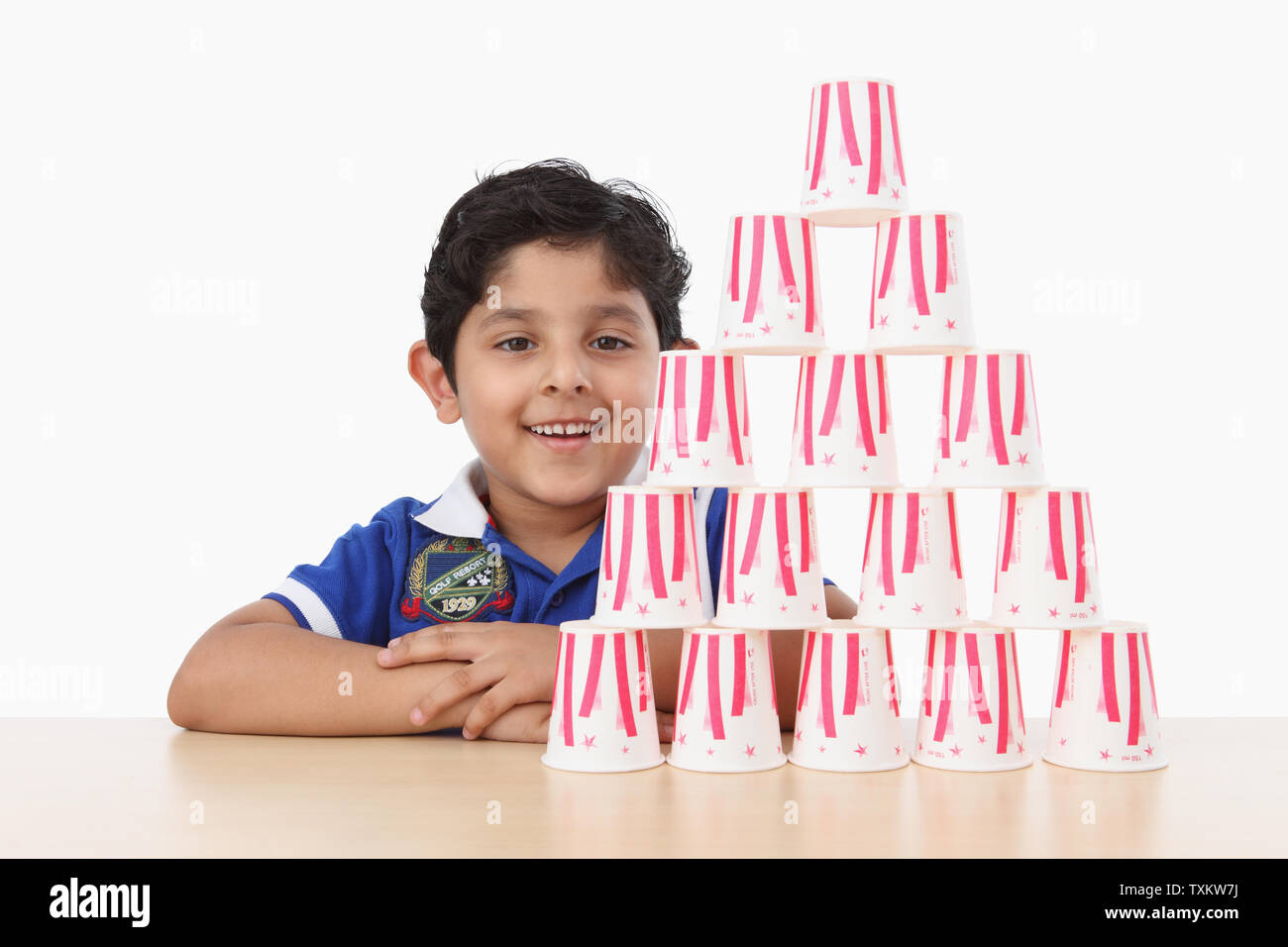 Boy building a disposable cups house Stock Photo - Alamy