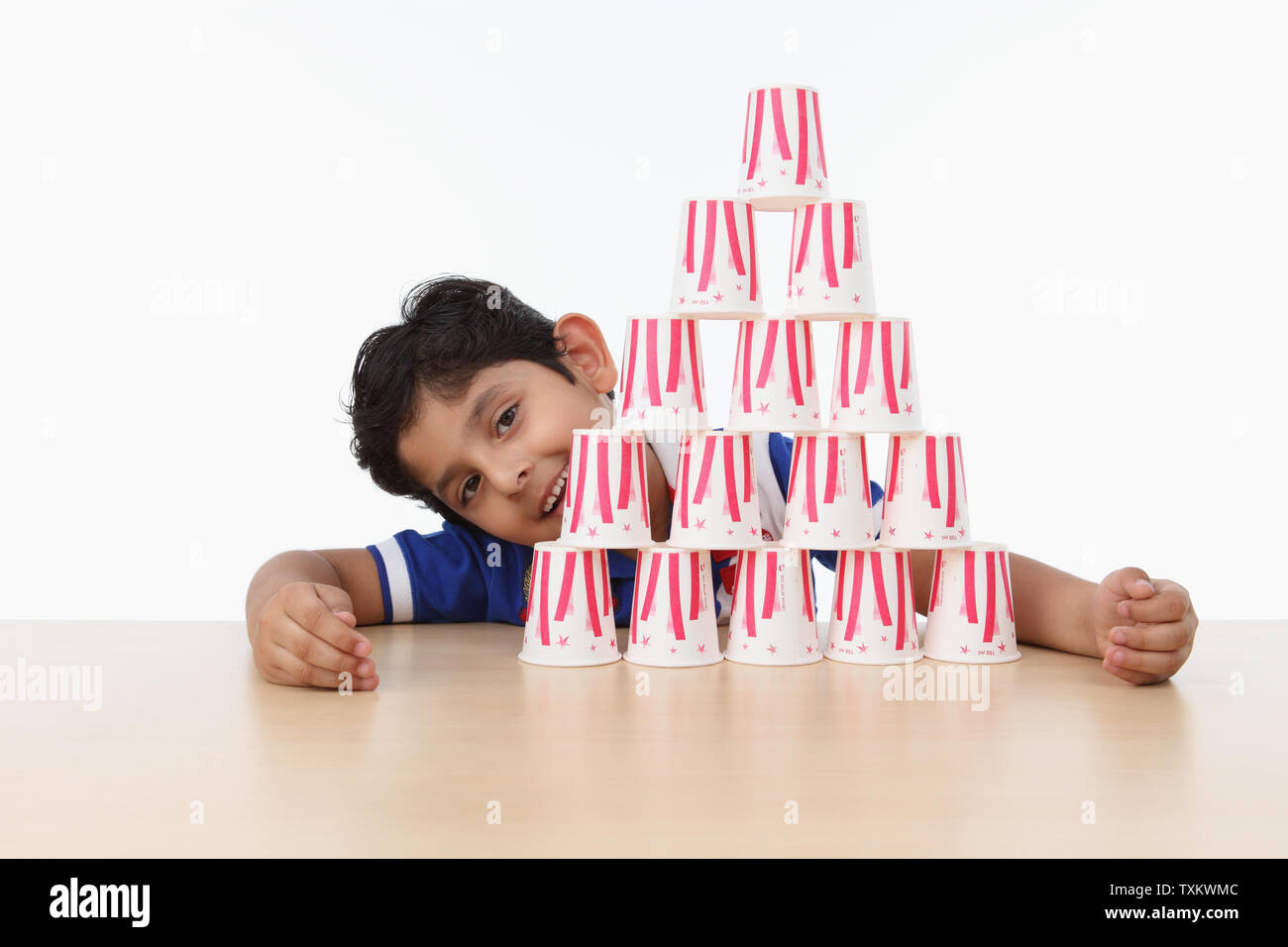 Boy building a disposable cups house Stock Photo - Alamy