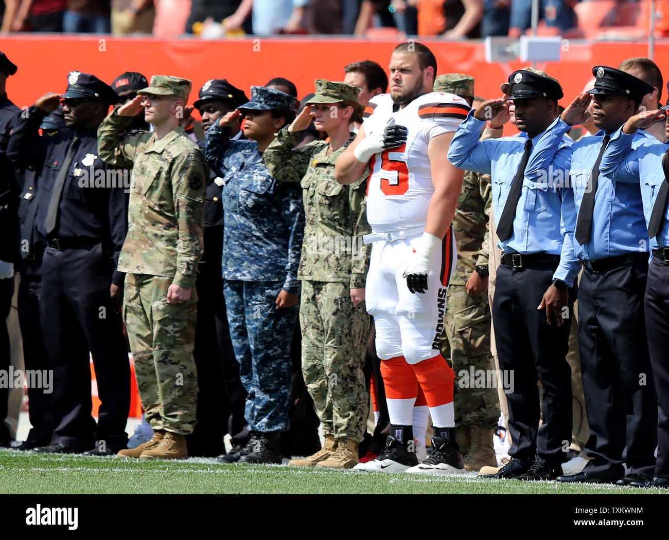Cleveland Browns Joel Bitonio stands for the national anthem along side ...