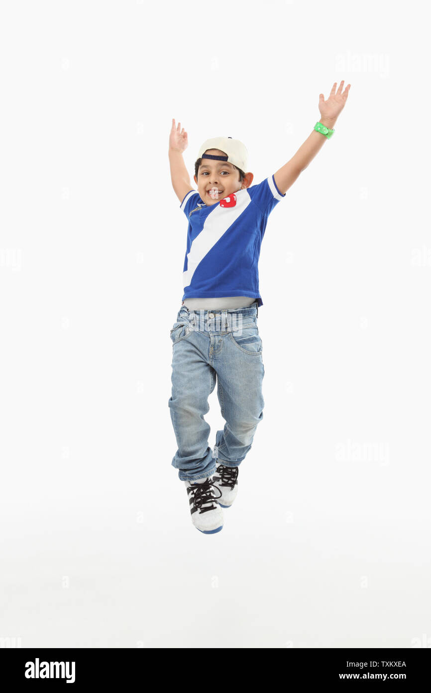 Boy jumping with arm outstretched Stock Photo - Alamy