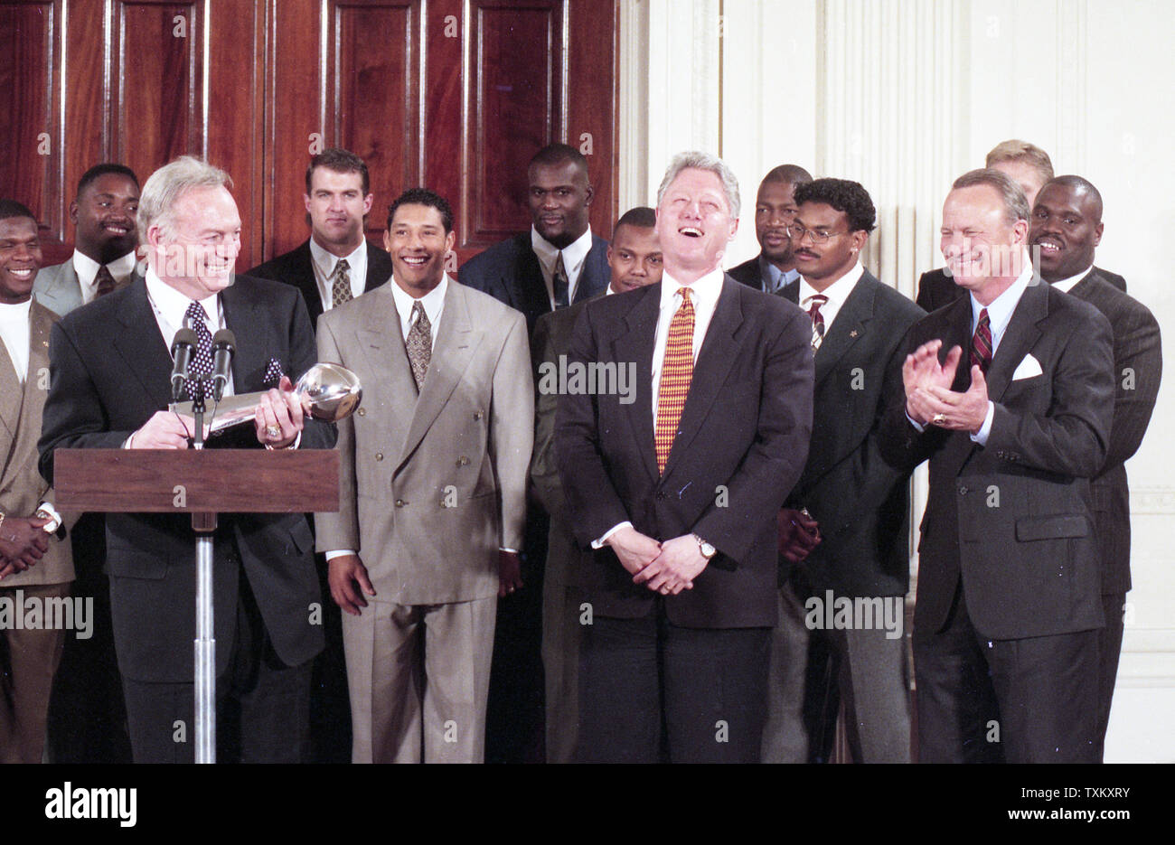 U.S. President Bill Clinton laughs as Dallas Cowboys owner Jerry Jones ...